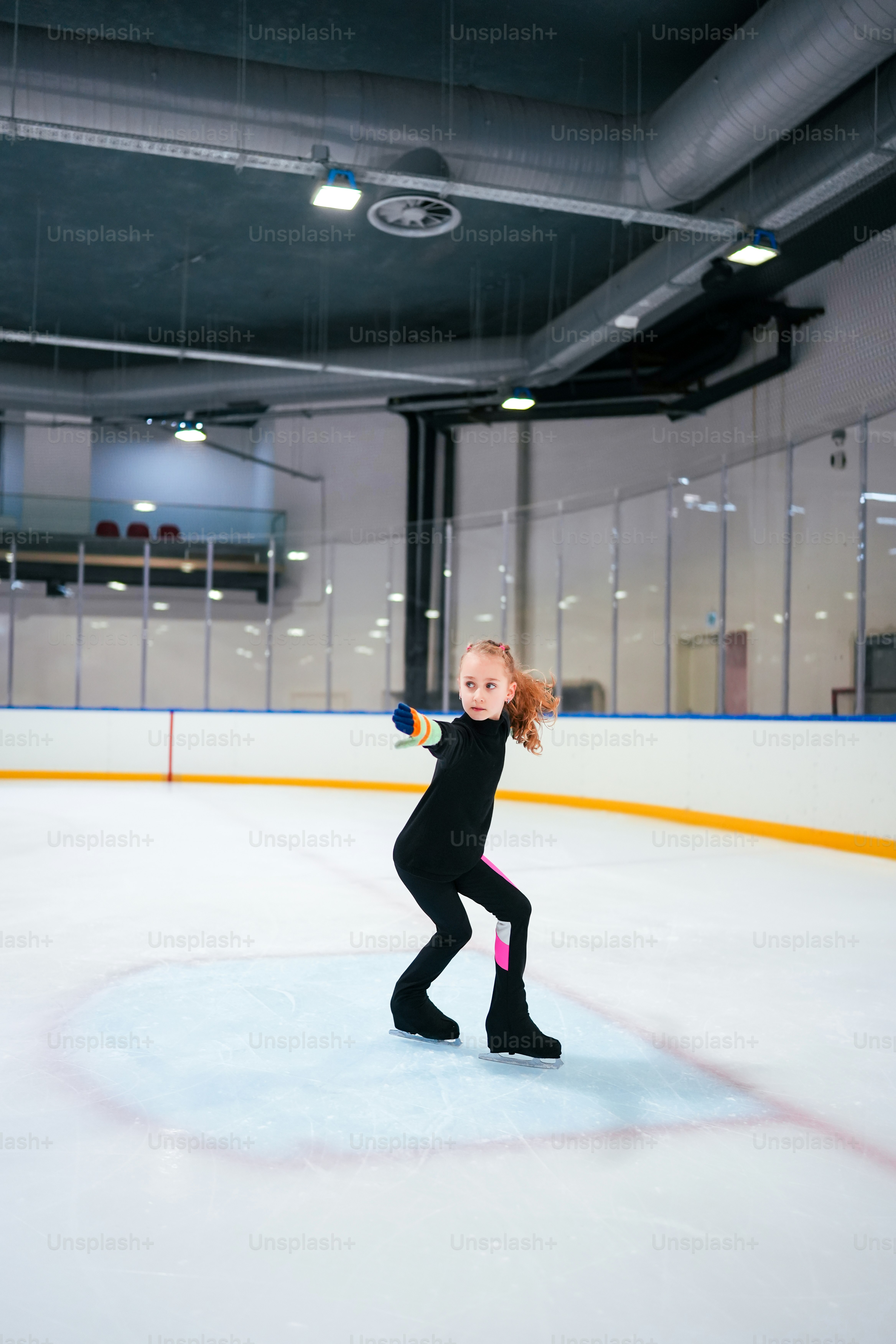 A young girl skating on an ice rink photo – Figure skating Image on ...
