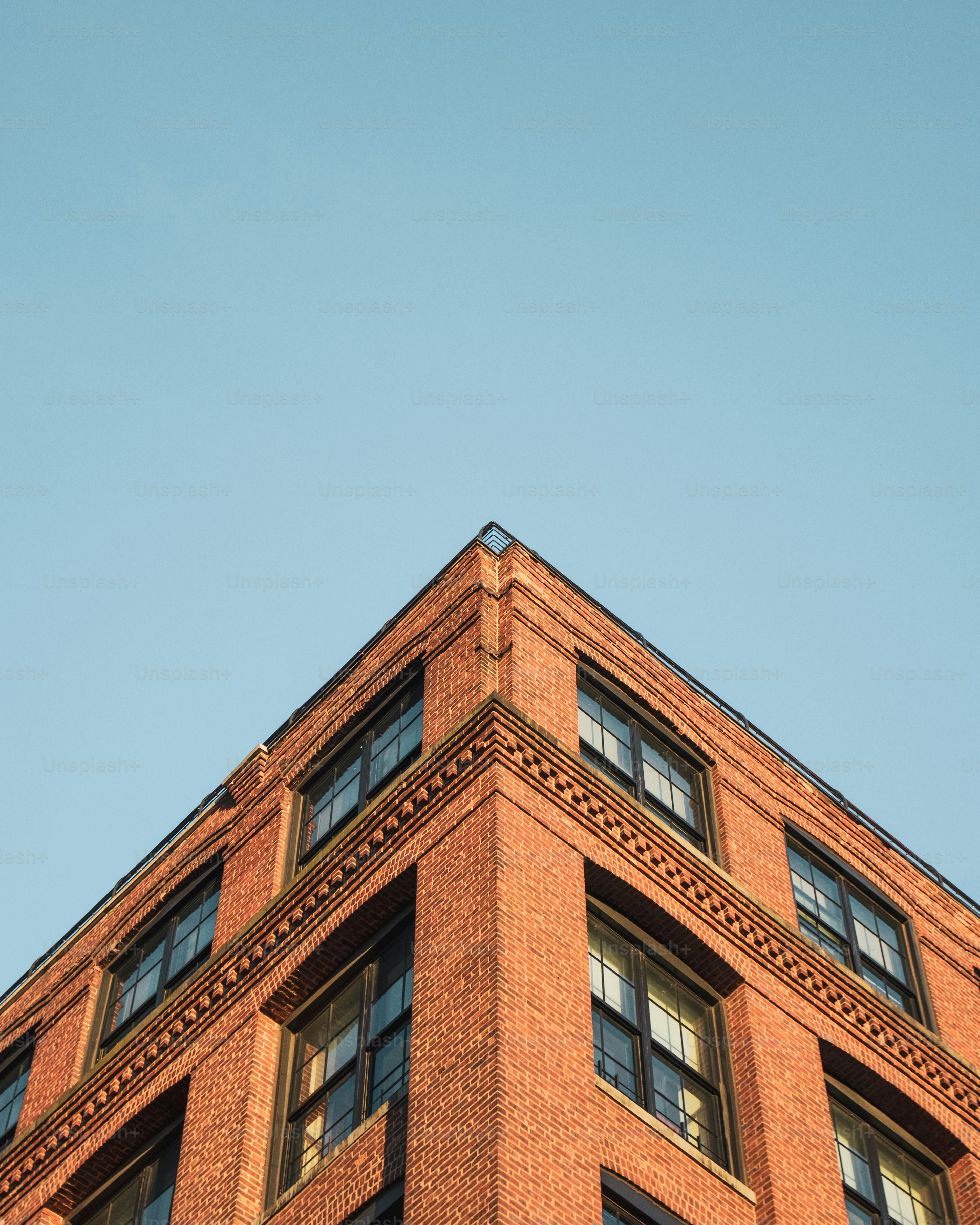 A very tall brick building with lots of windows photo – Street Image on ...