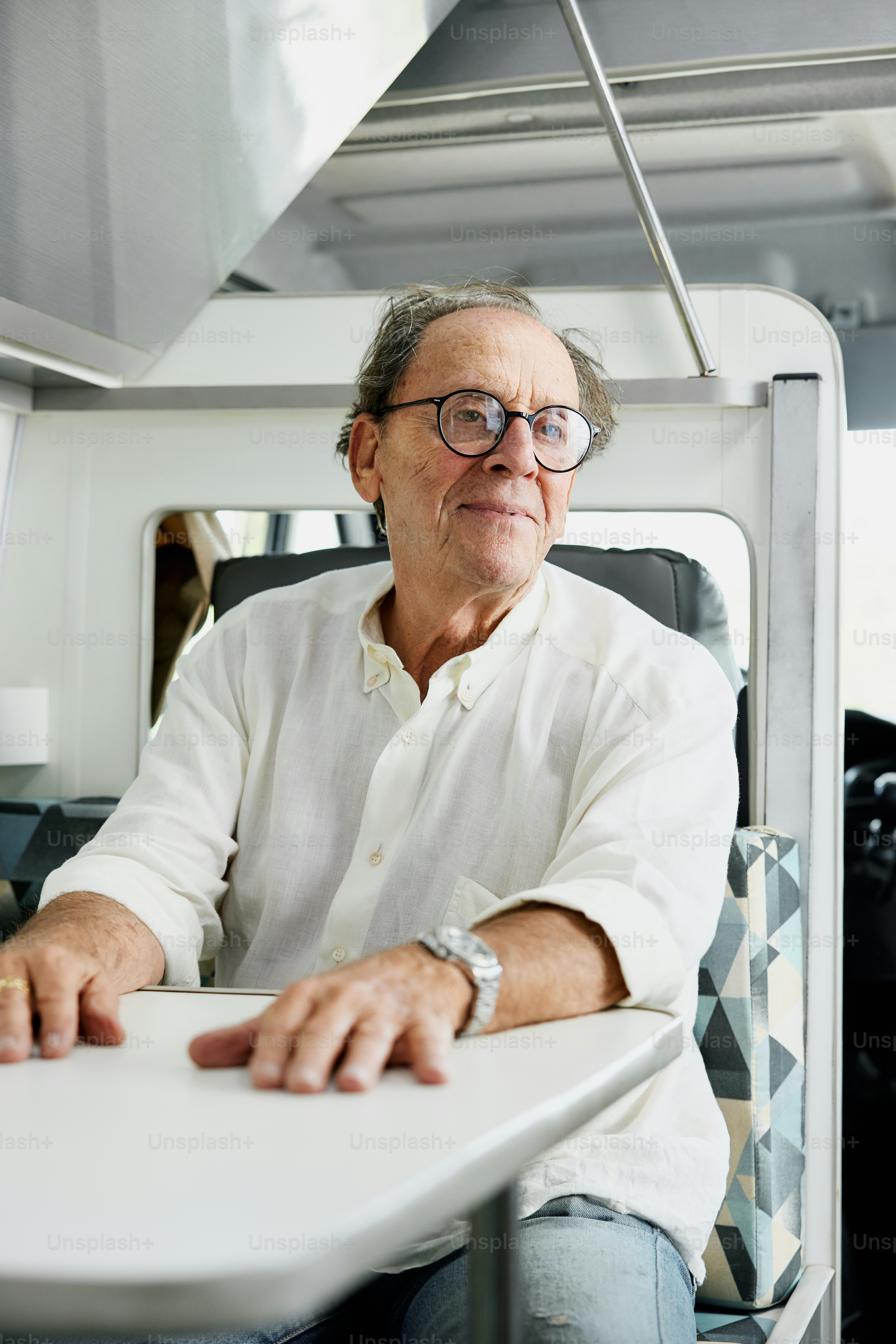 A man sitting at a table on a train photo – Elders Image on Unsplash