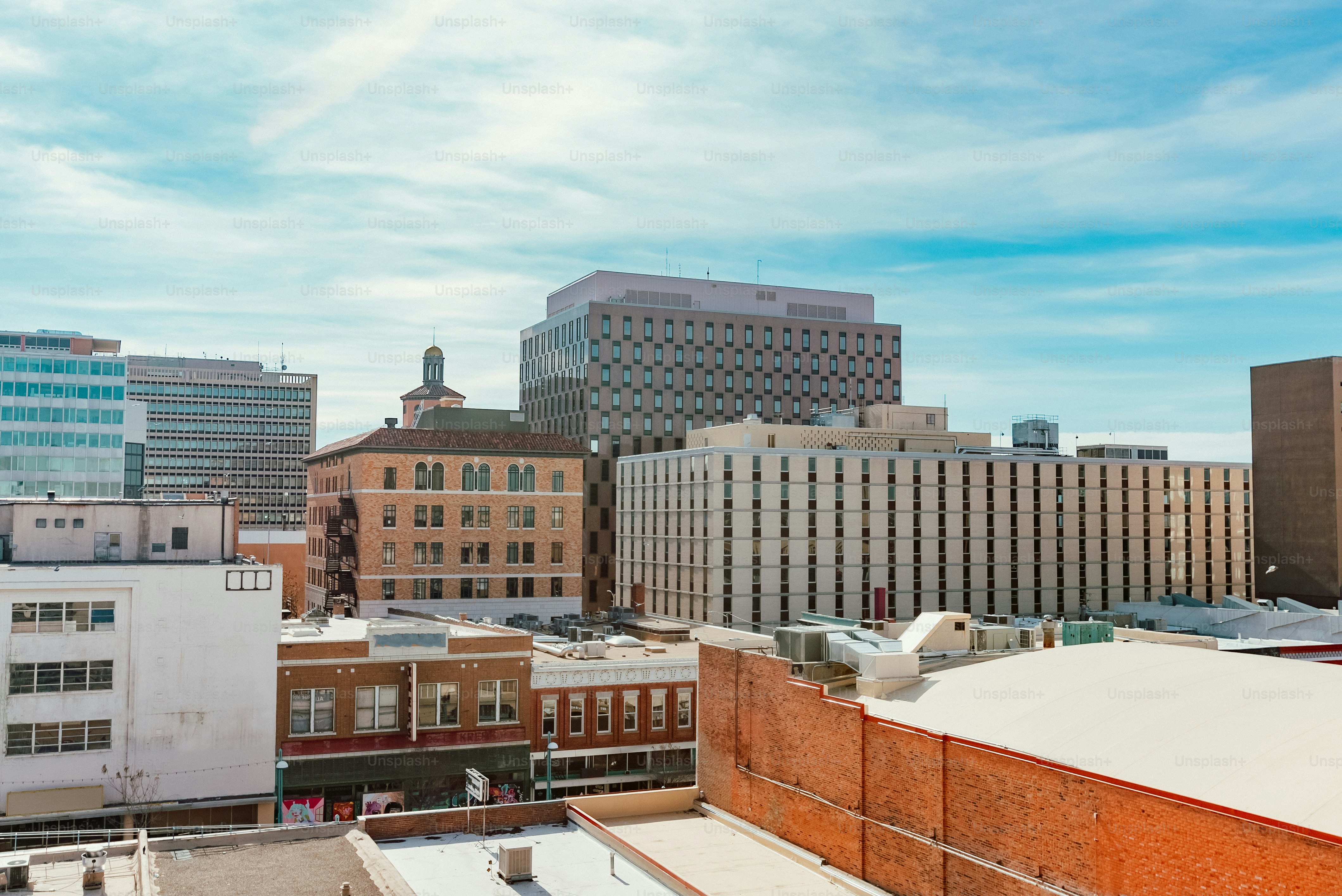 A city street with tall buildings in the background photo – Albuquerque ...