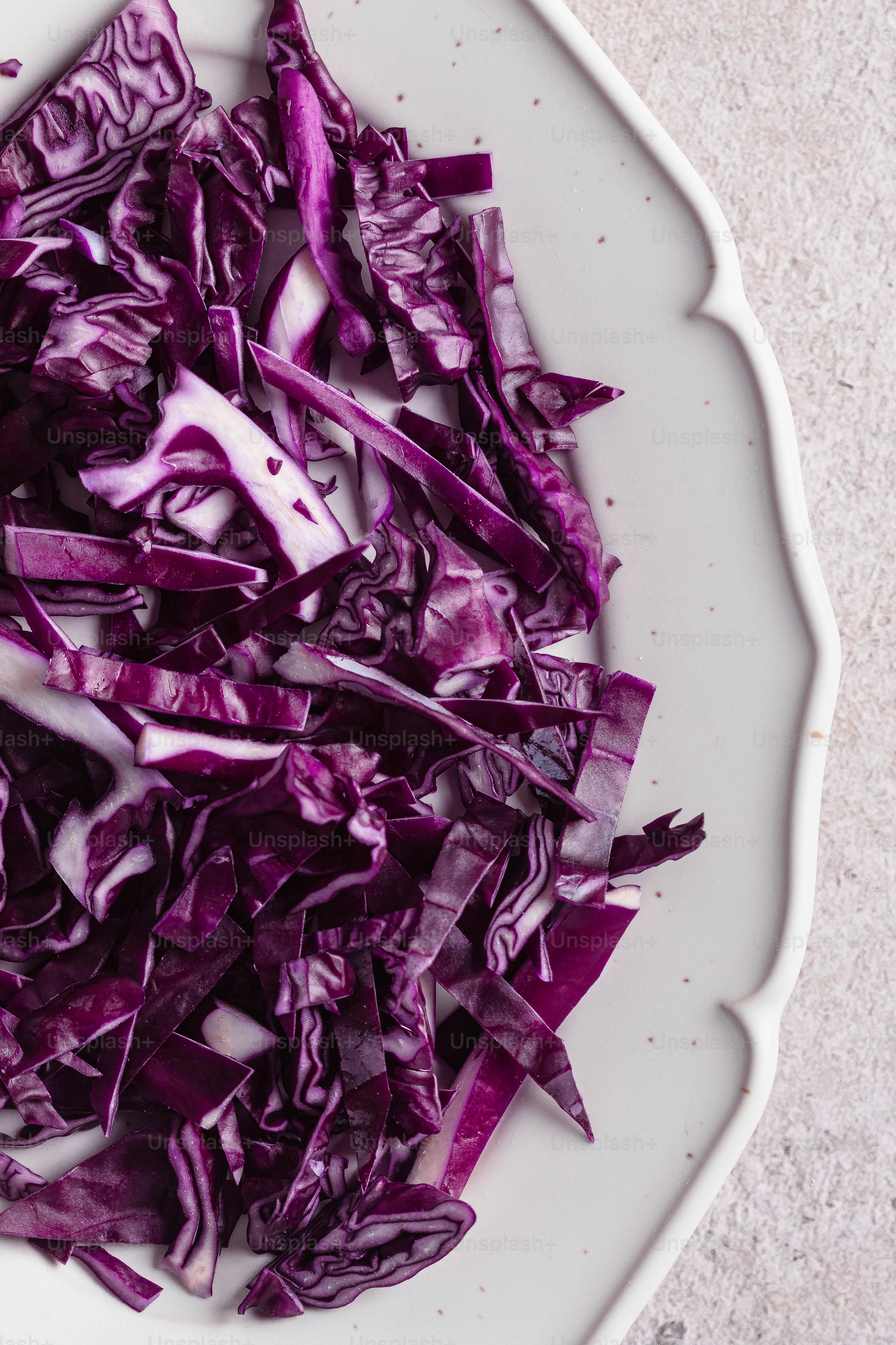 A white plate topped with sliced red cabbage photo – Red cabbage Image ...