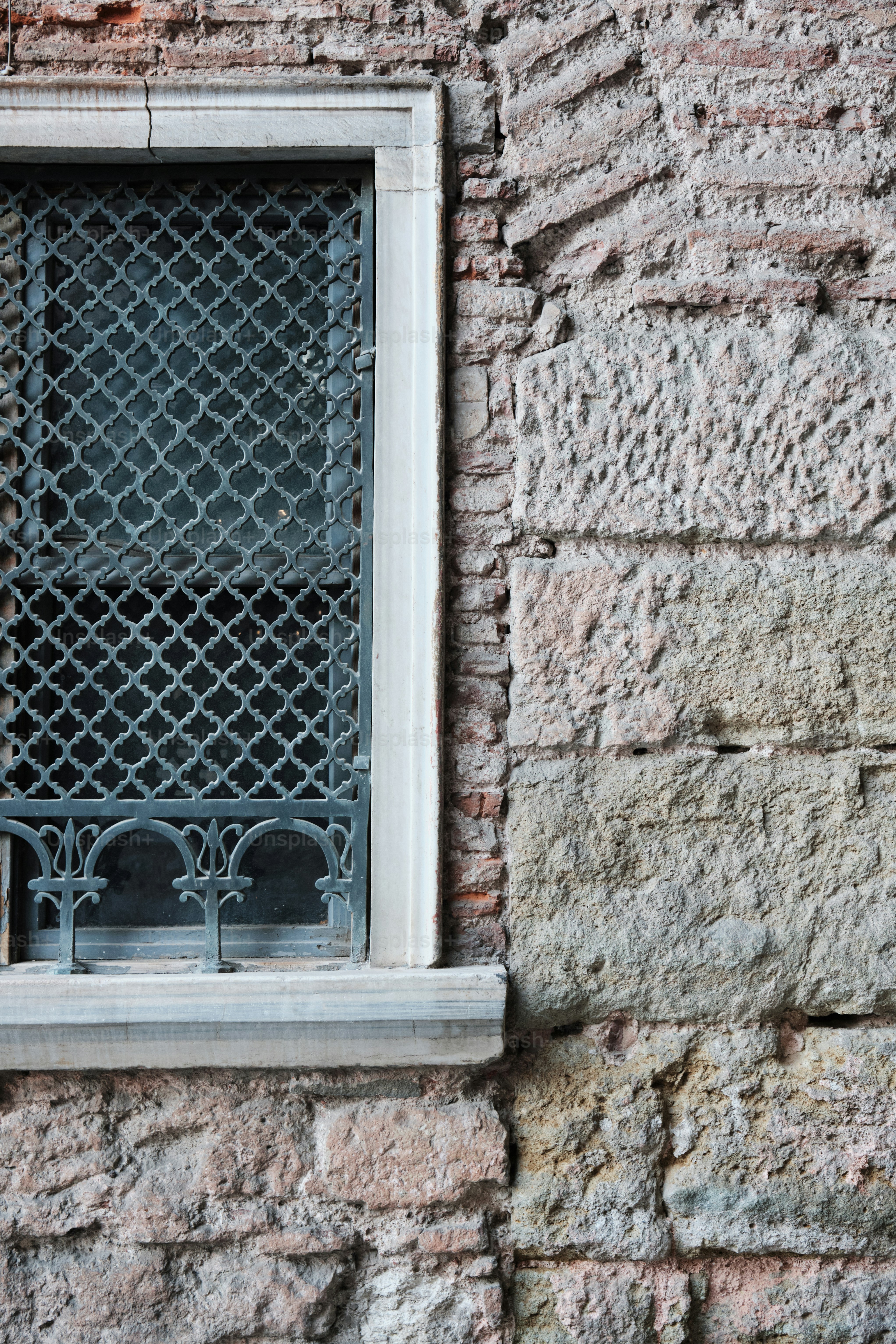 A window on a brick wall with a wrought iron grill photo – Texture ...