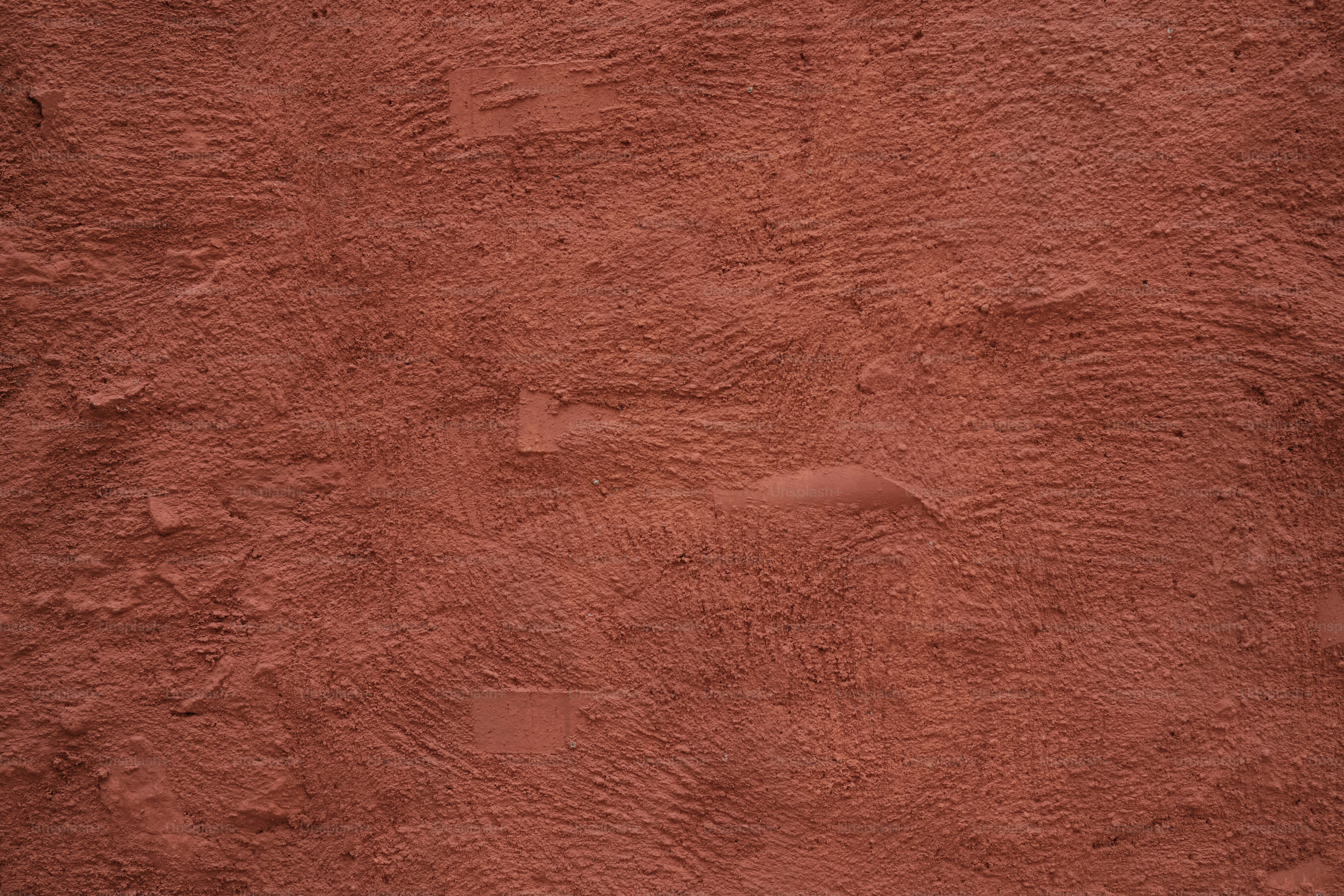 A close up of a red stucco wall photo – Texture Image on Unsplash