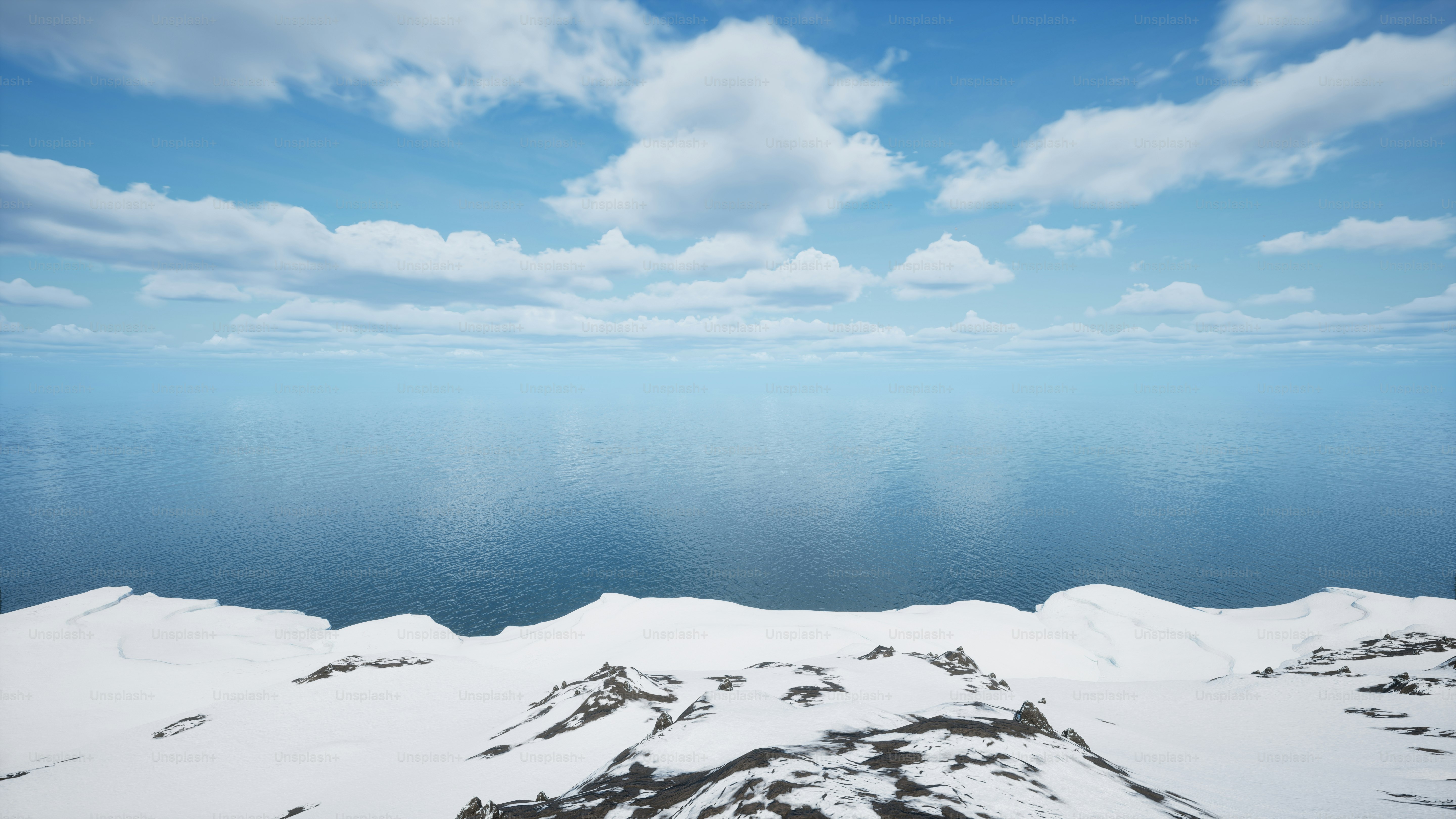 A large body of water surrounded by snow covered mountains photo – Snow ...