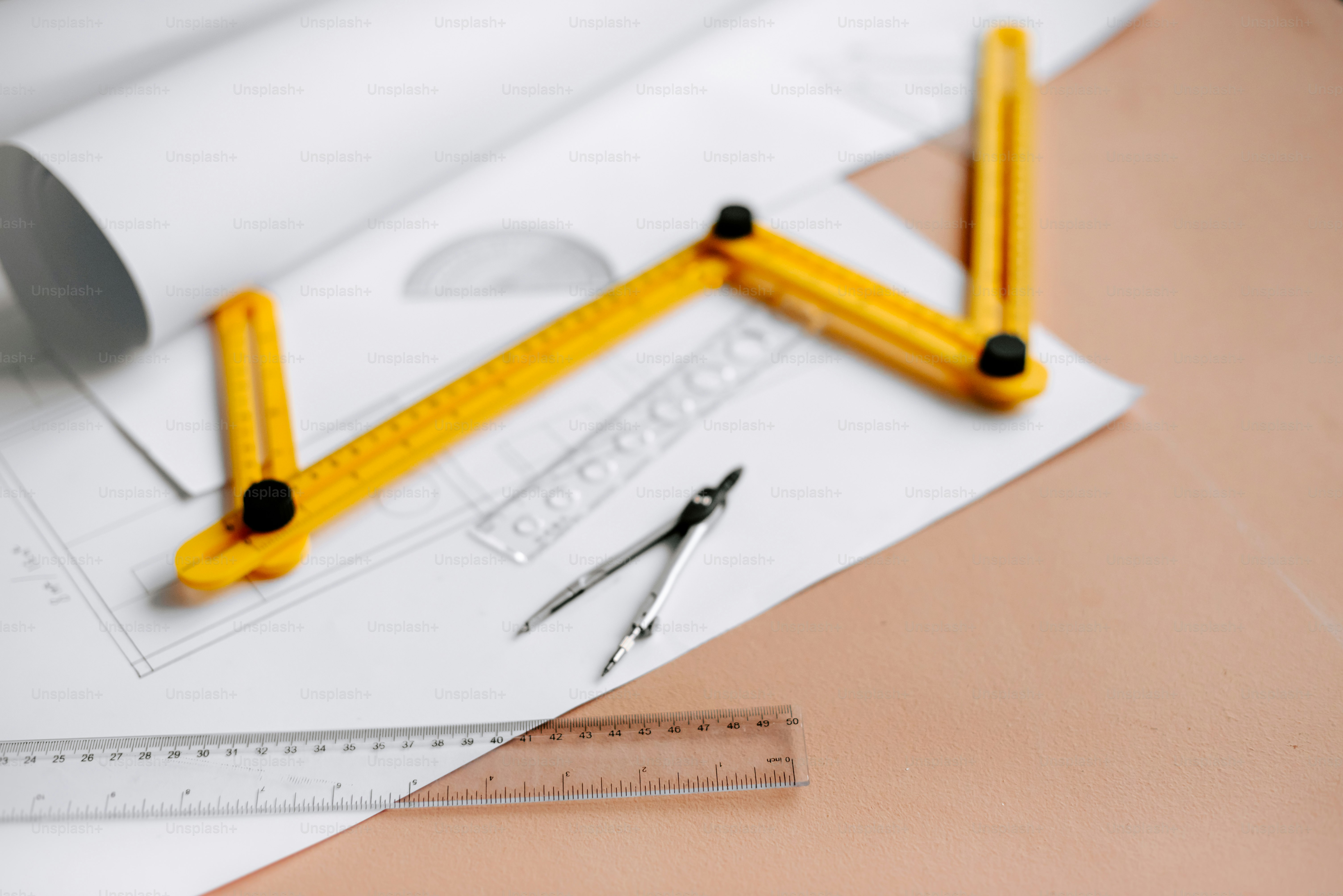 A ruler, rulers, and a pair of scissors on a table photo – Geometry ...