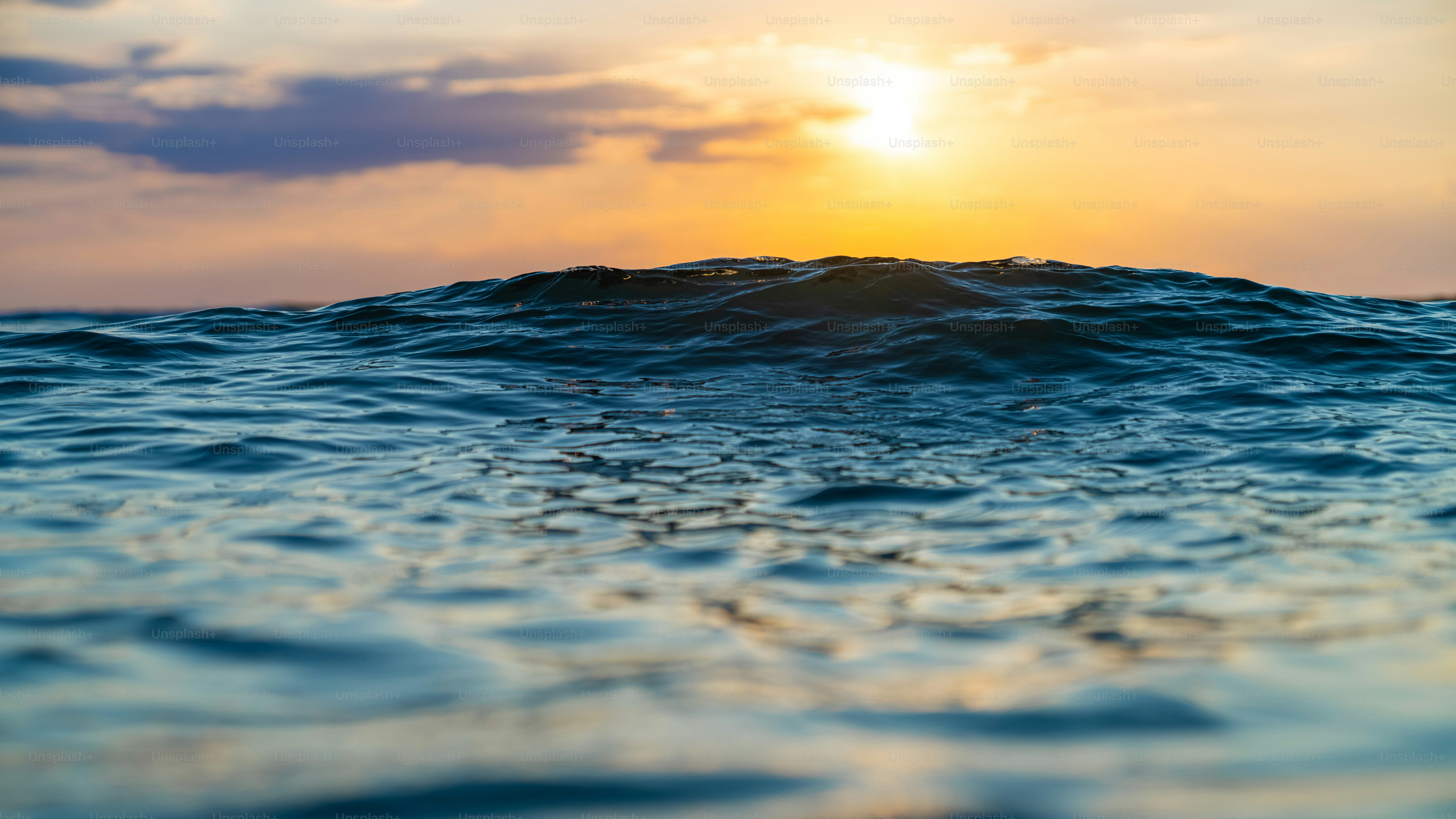 The sun is setting over the ocean waves photo – Morning beach Image on ...