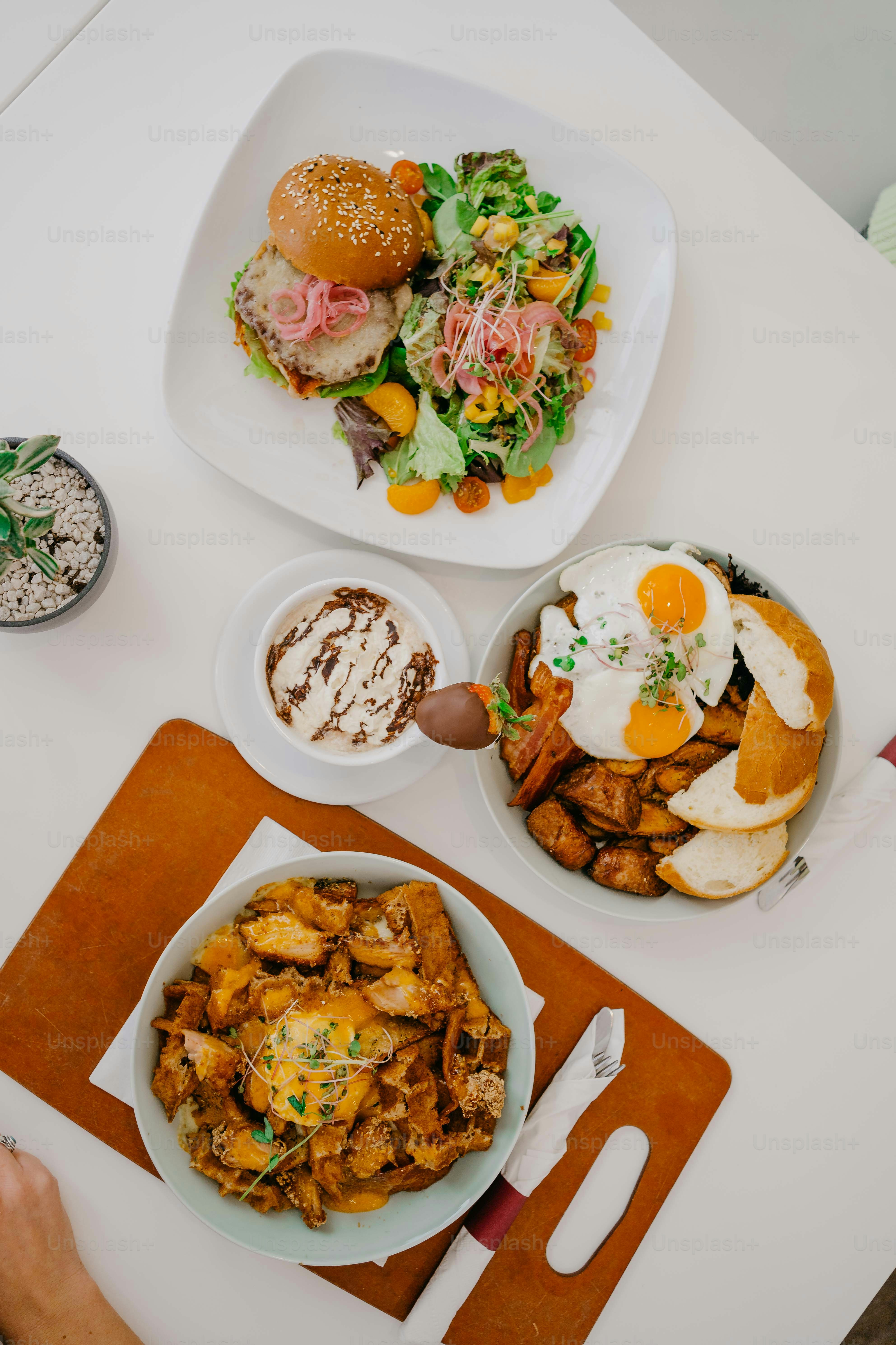 A table topped with plates of food and bowls of food photo – Food Image ...