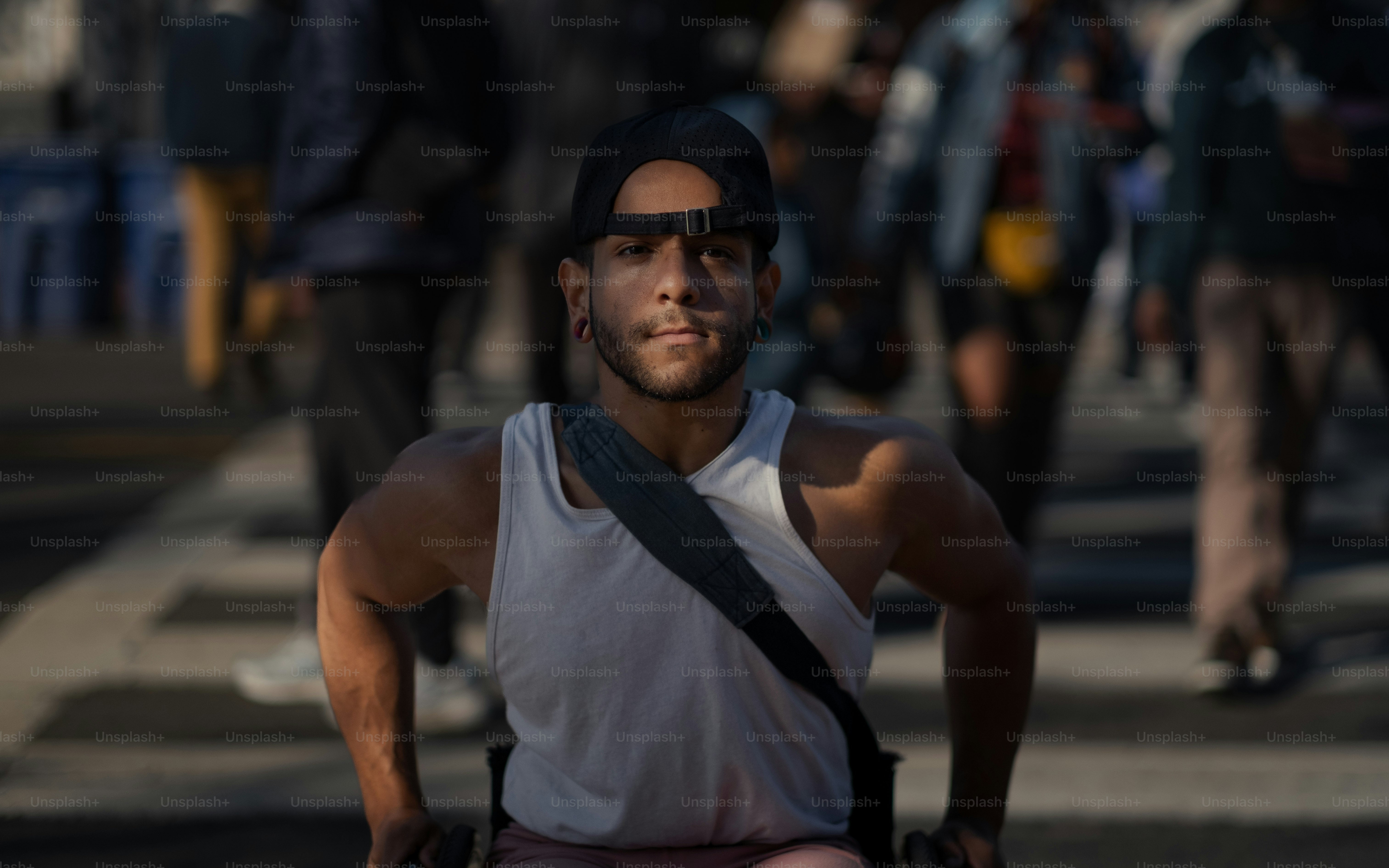 A man with a camera strapped to his shoulder photo – Disability Image ...