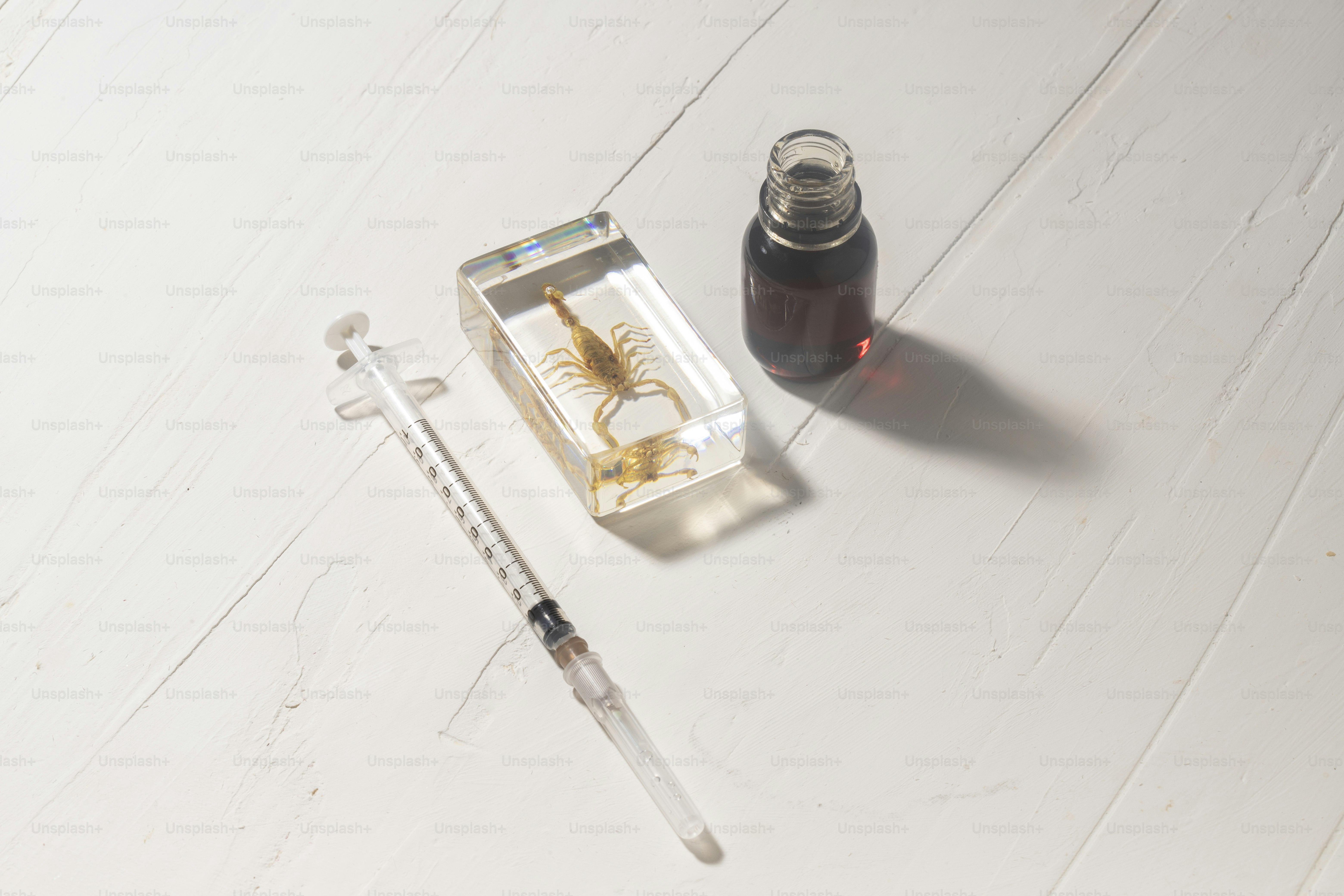 A bottle of liquid next to a syringe and a syringe photo – Needle Image ...