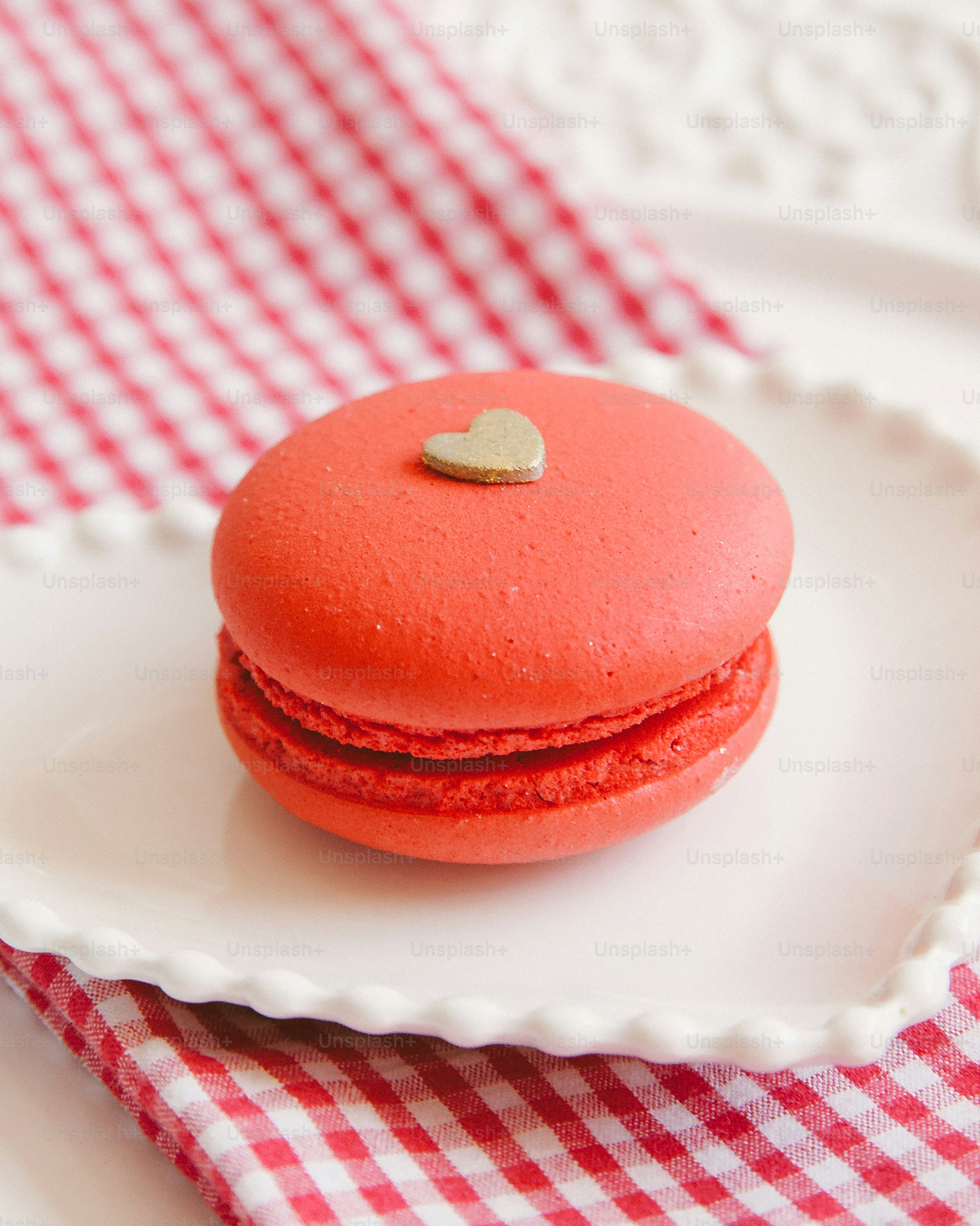 A red macaroon sitting on a white plate photo – Macaron Image on Unsplash