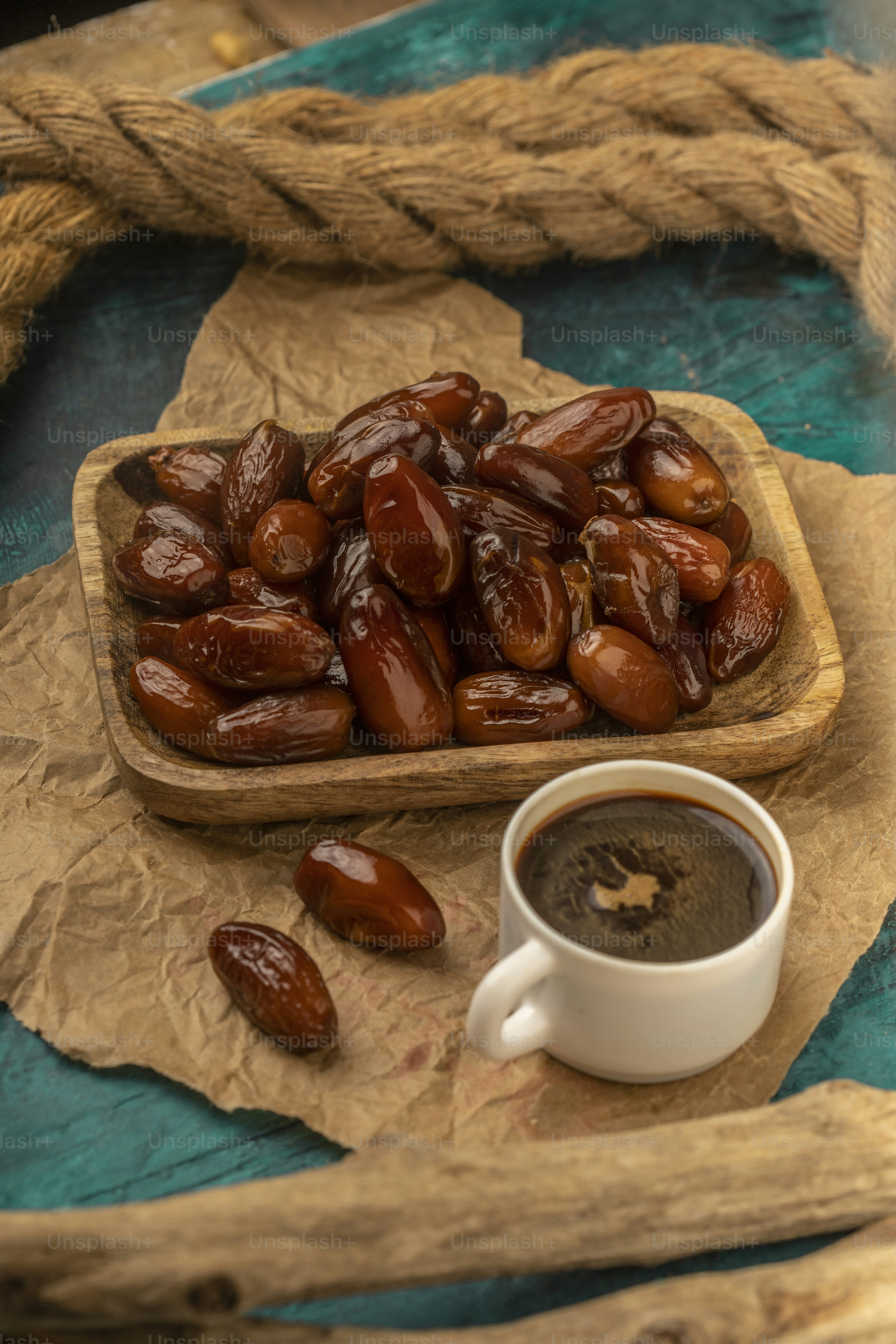 A cup of coffee next to a tray of dates photo – Dates Image on Unsplash