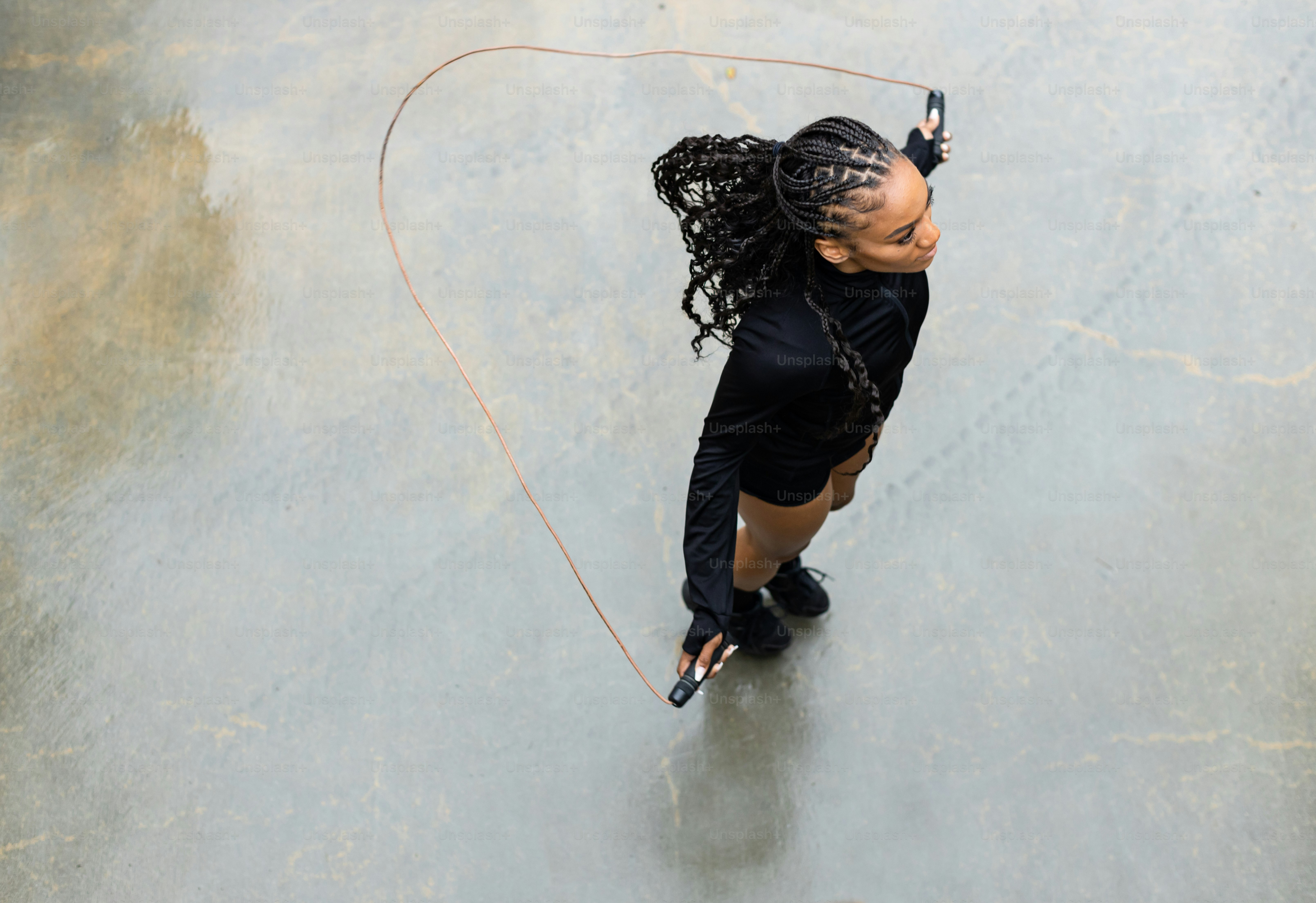 A woman in a black shirt is holding a rope photo – Motivational Image ...