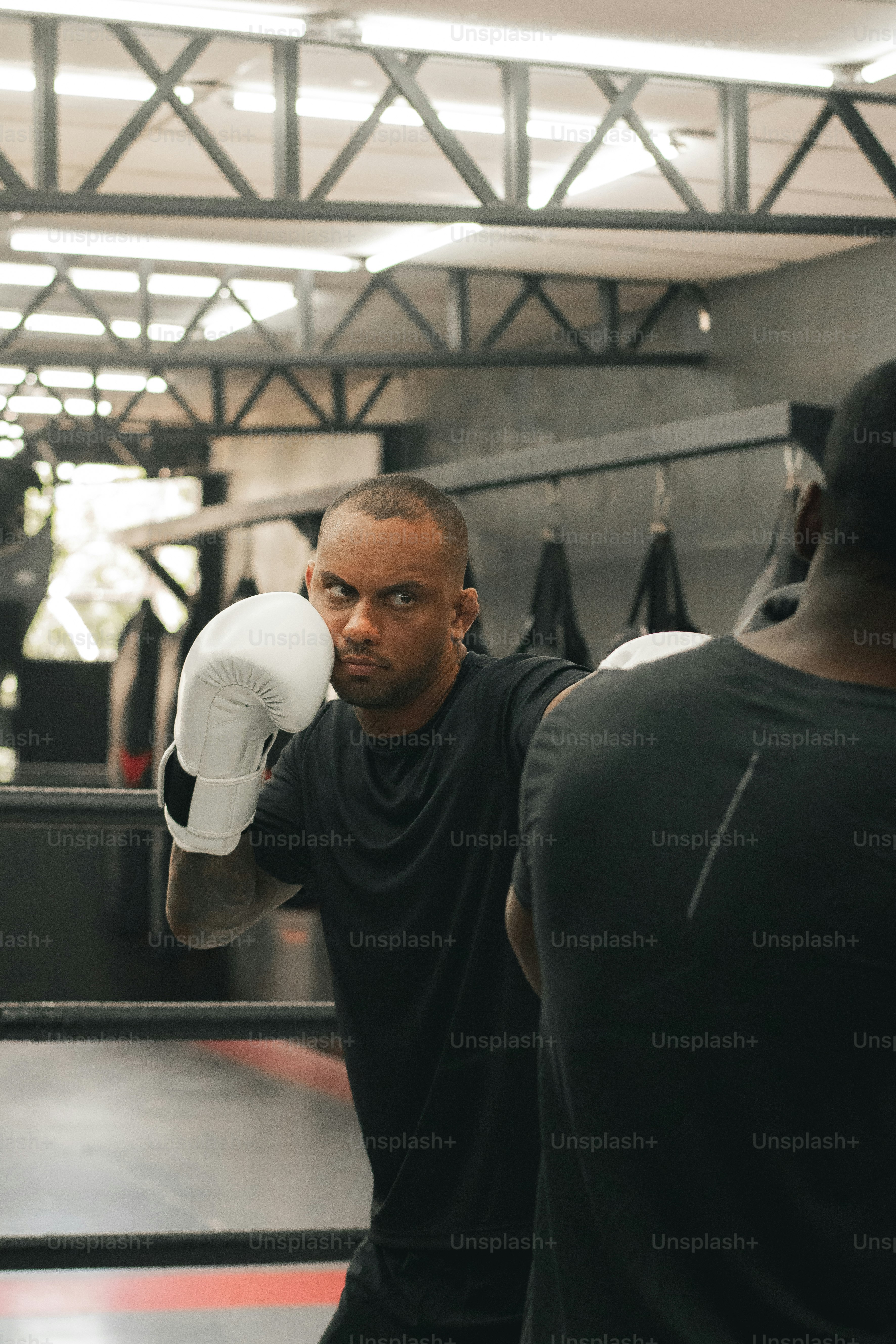 A man in a boxing ring holding a boxing glove photo – Boxing Image on ...