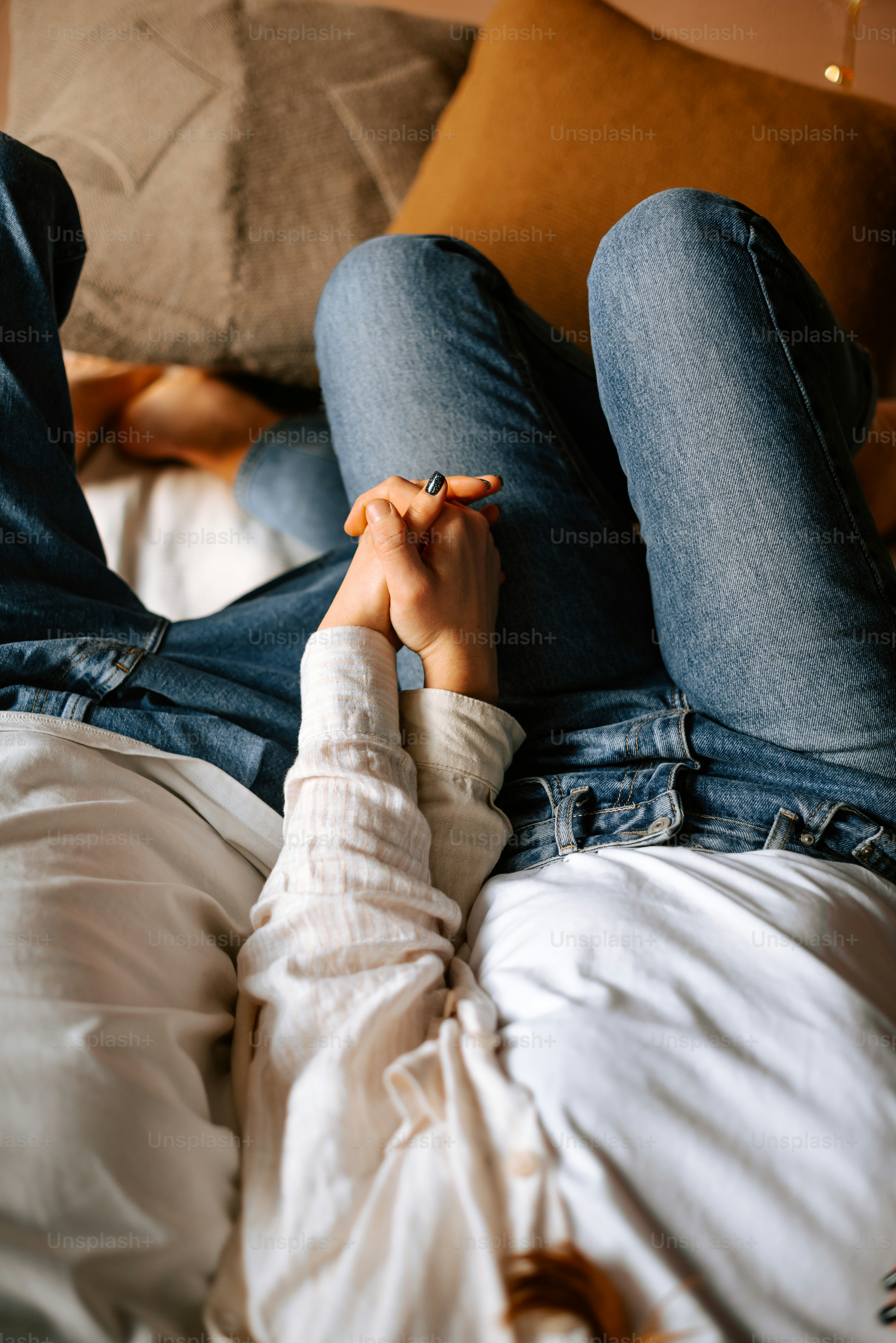 A person laying on a bed with their legs crossed photo – Sad couple ...
