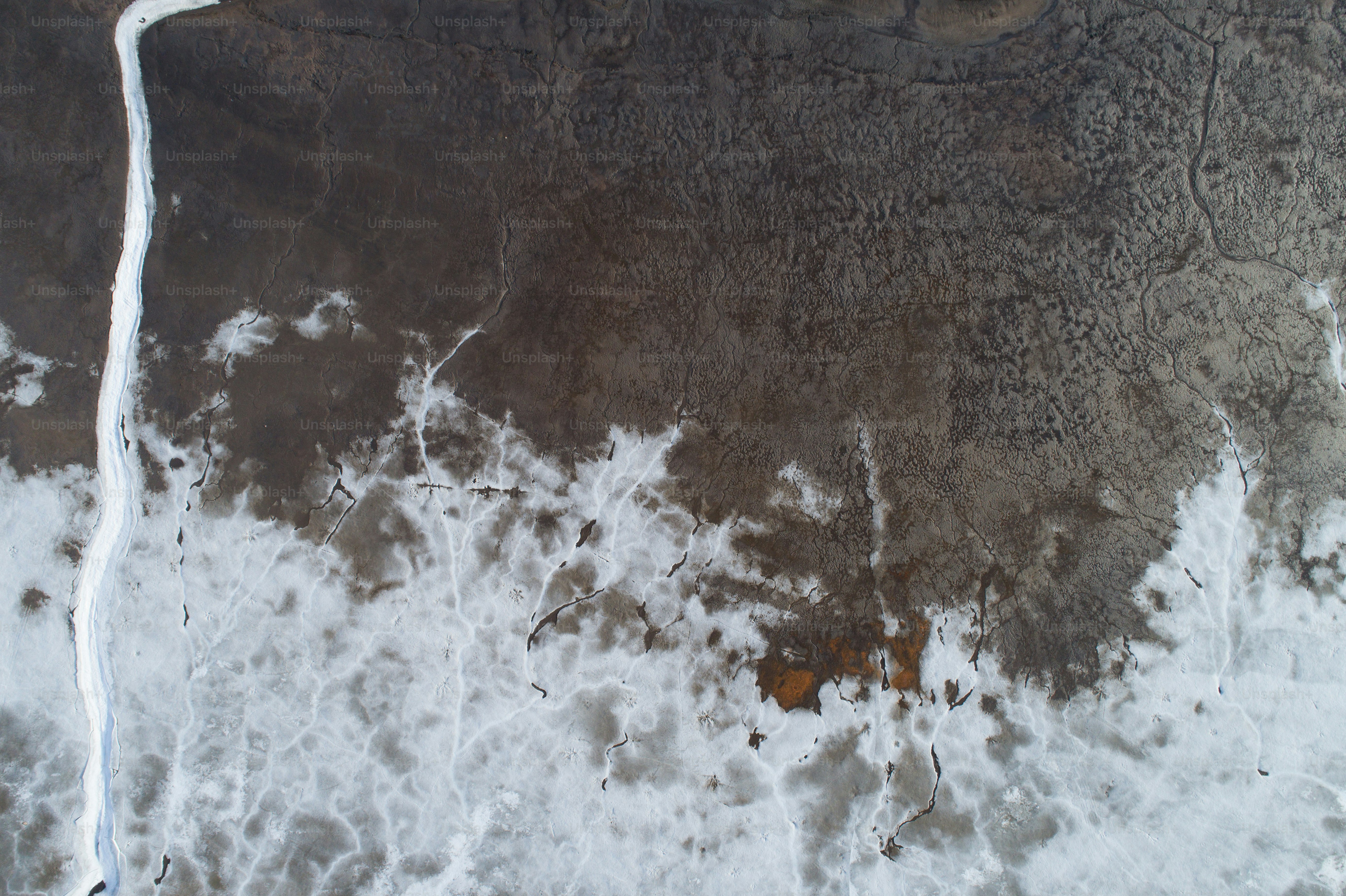 An aerial view of water and land from above photo – Texture Image on ...