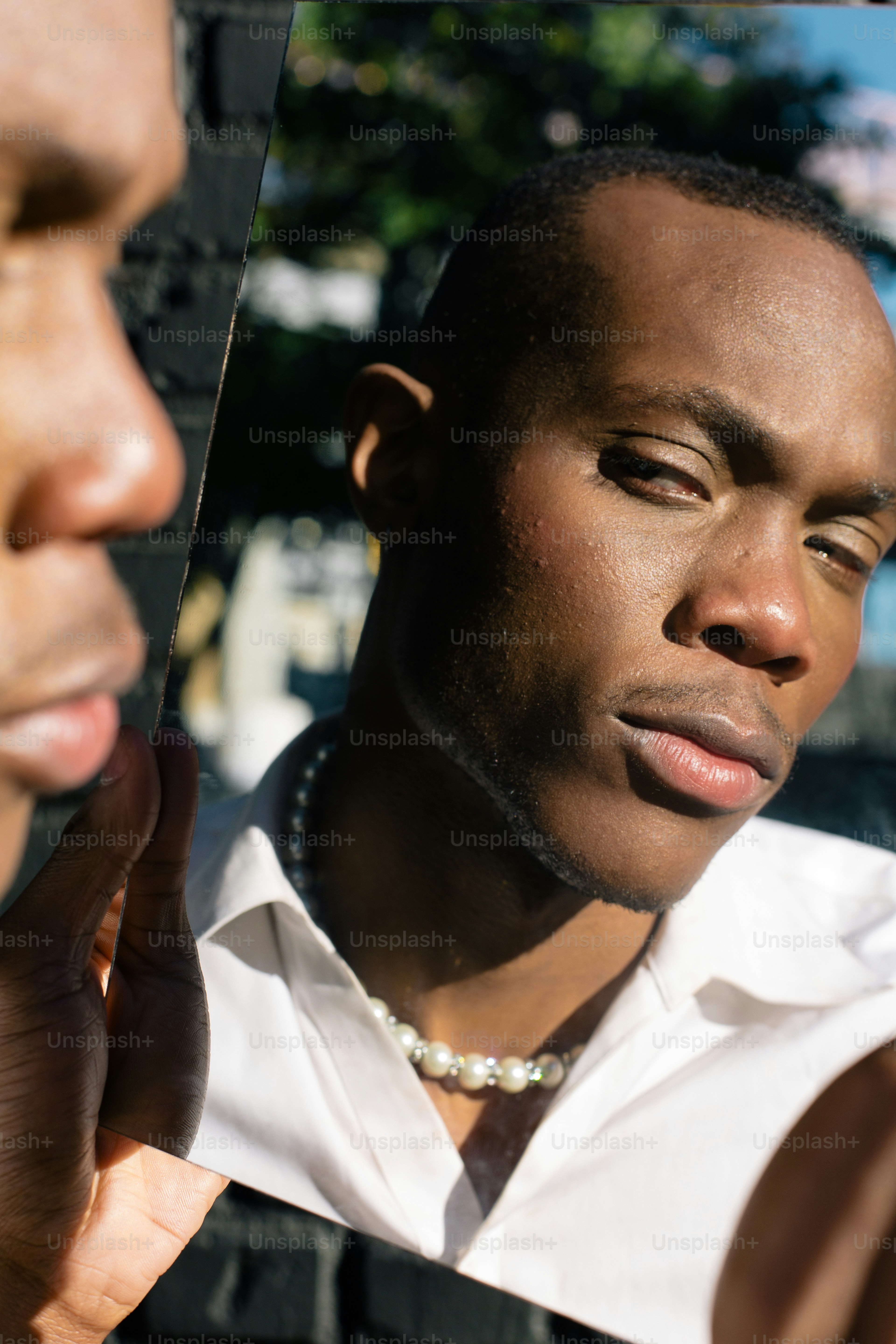 A man looking at his reflection in a mirror photo – Mirror Image on ...