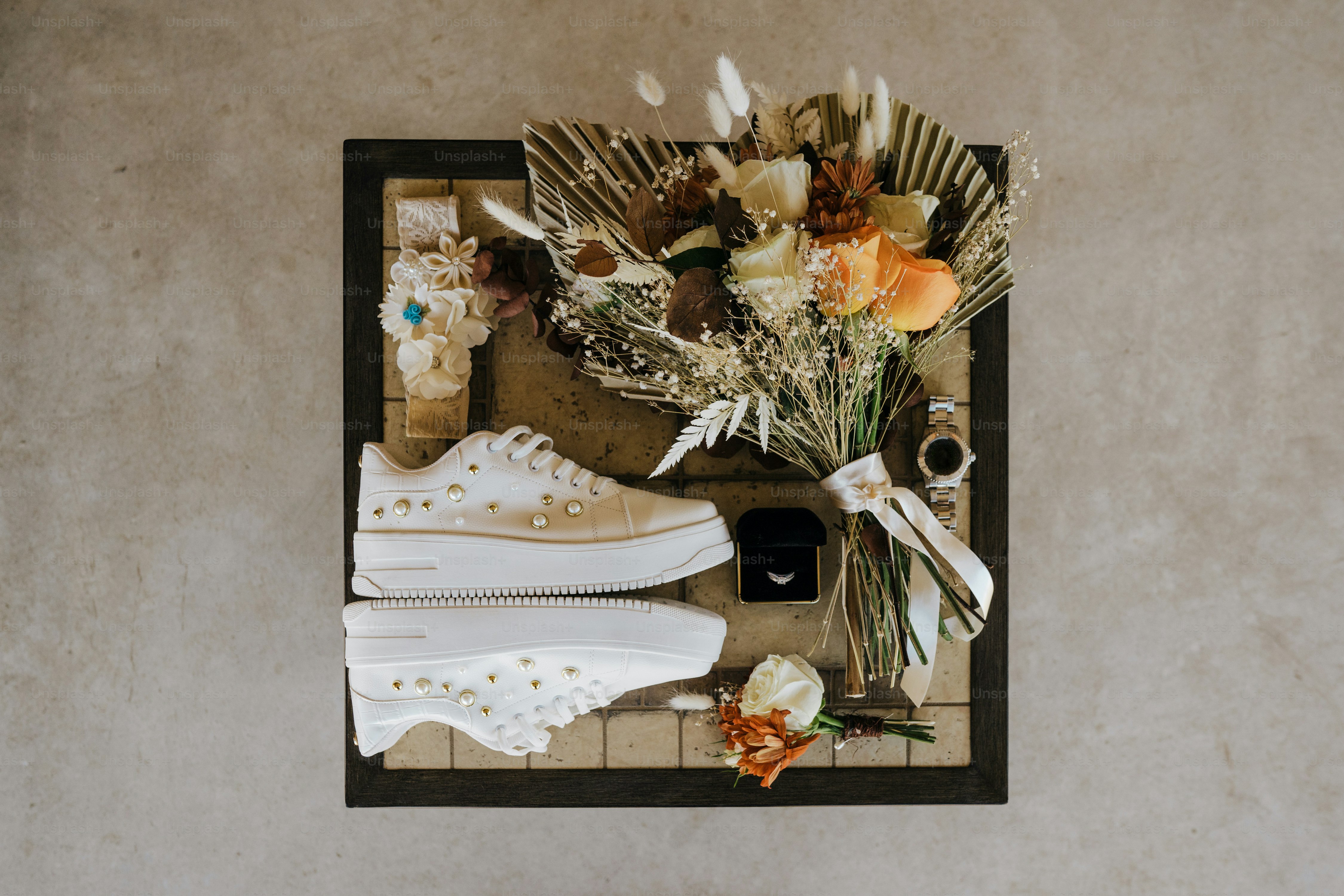 A pair of white sneakers sitting on top of a table photo – Flowers ...