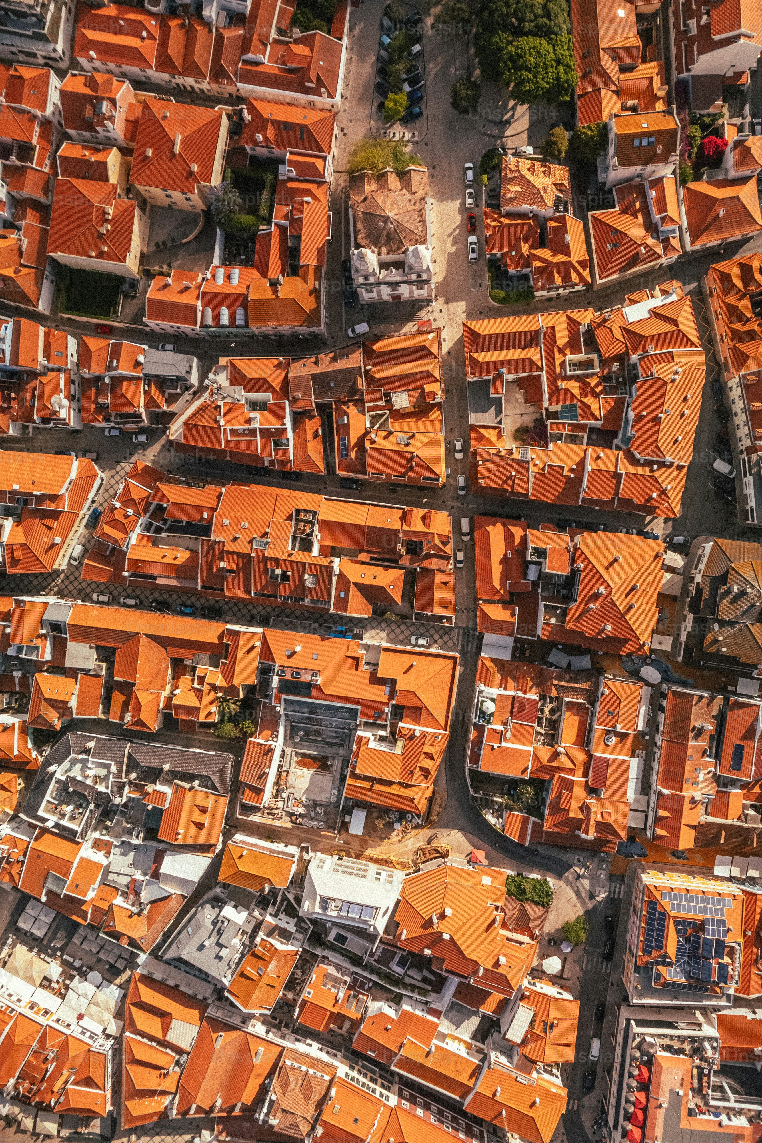 An aerial view of a city with orange roofs photo – Suburb Image on Unsplash