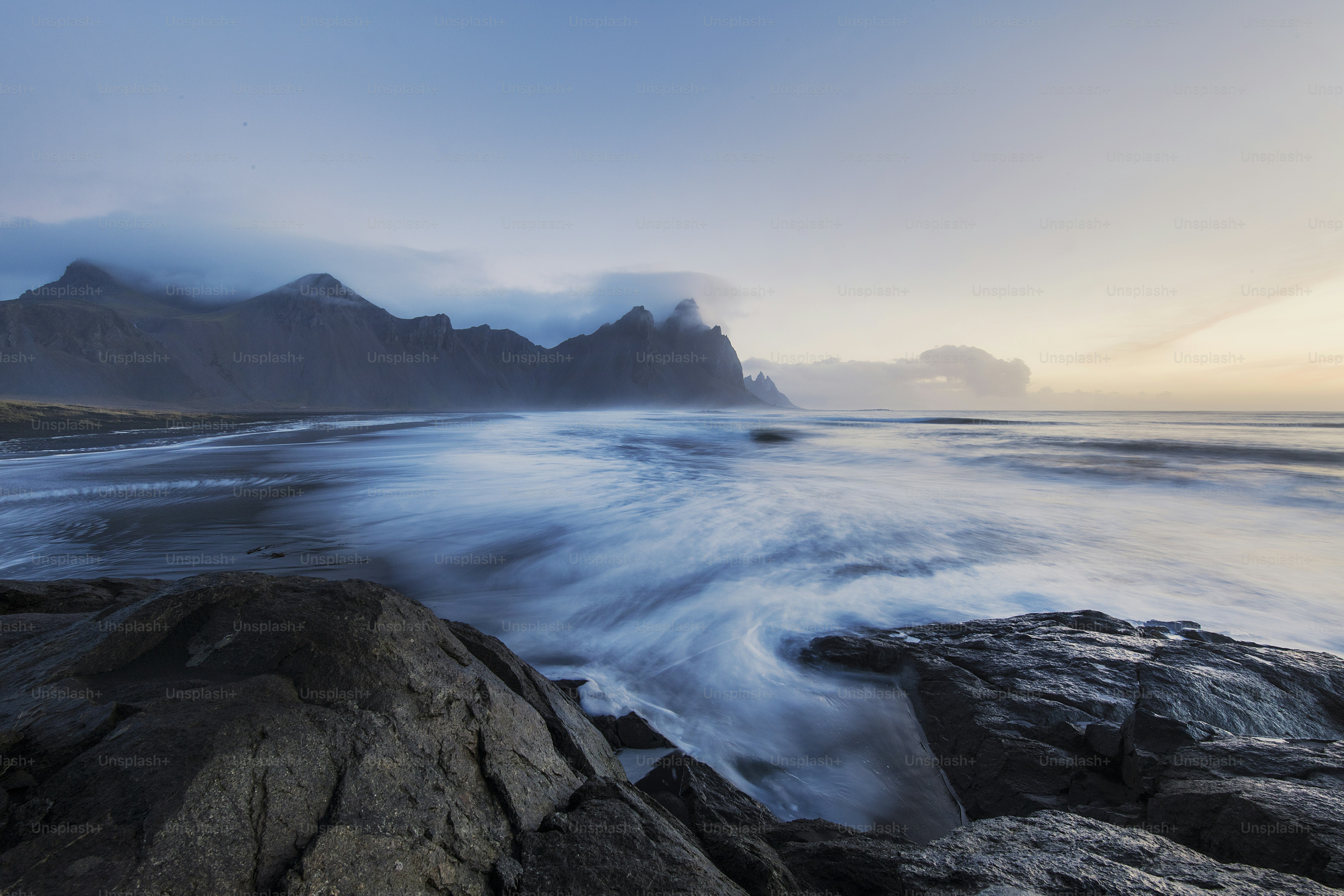 A large body of water surrounded by rocks photo – Iceland Image on Unsplash