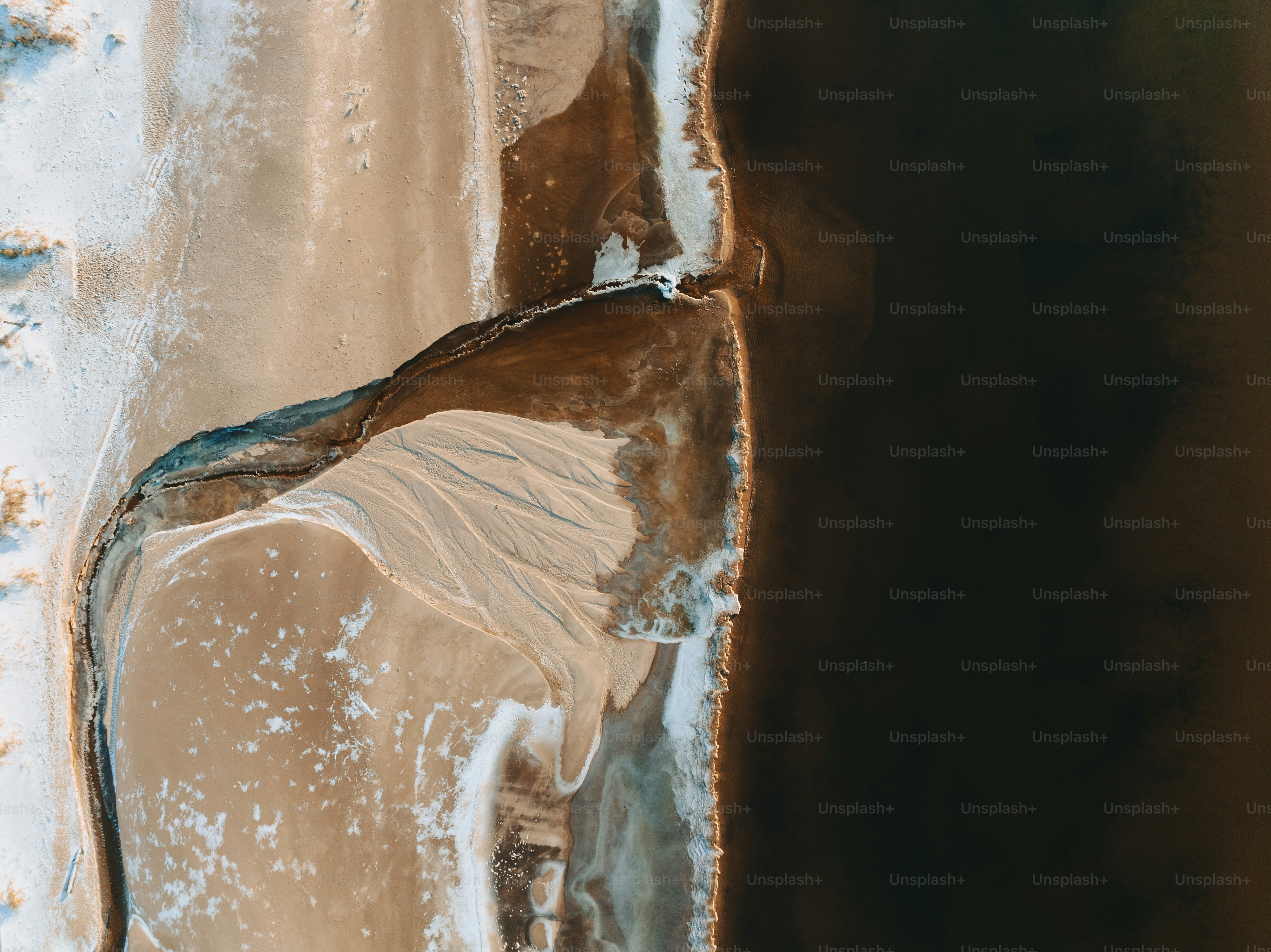 A bird's eye view of a beach and water photo – Estuary Image on Unsplash