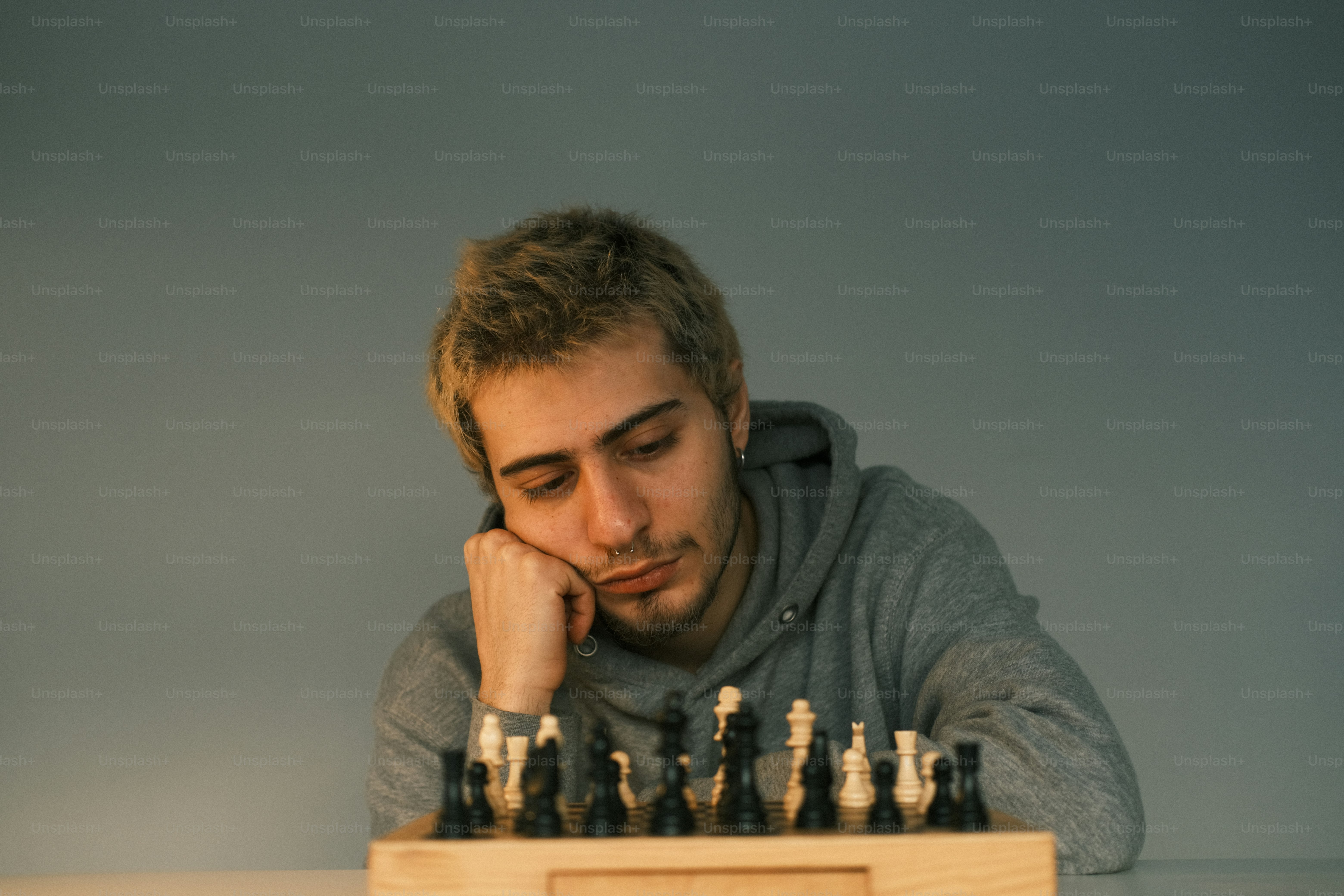 A man sitting in front of a chess board photo – Sport Image on Unsplash