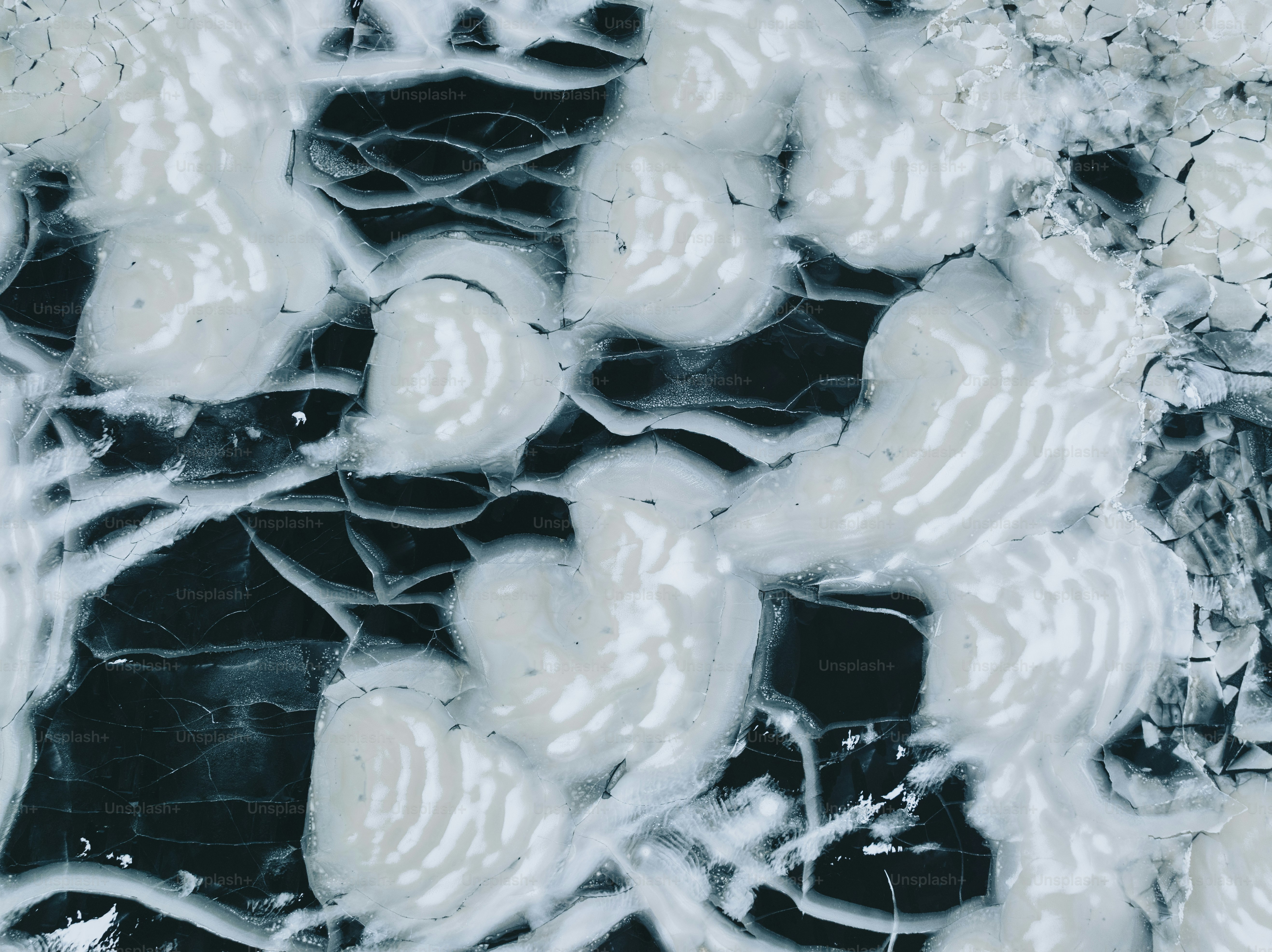A close up of a black and white marble photo – Snow Image on Unsplash