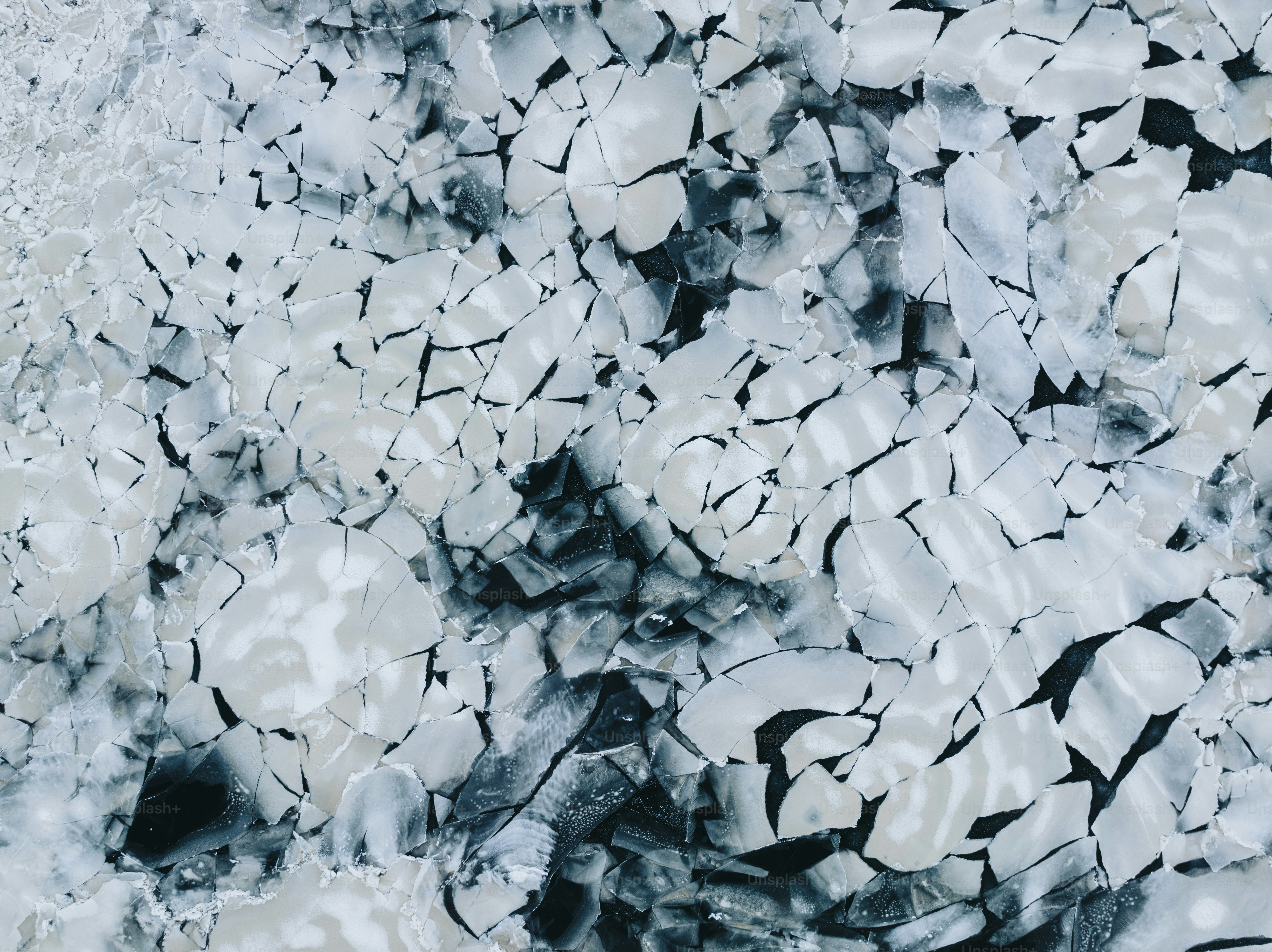 An aerial view of ice and snow on the ground photo – Blocks Image on ...