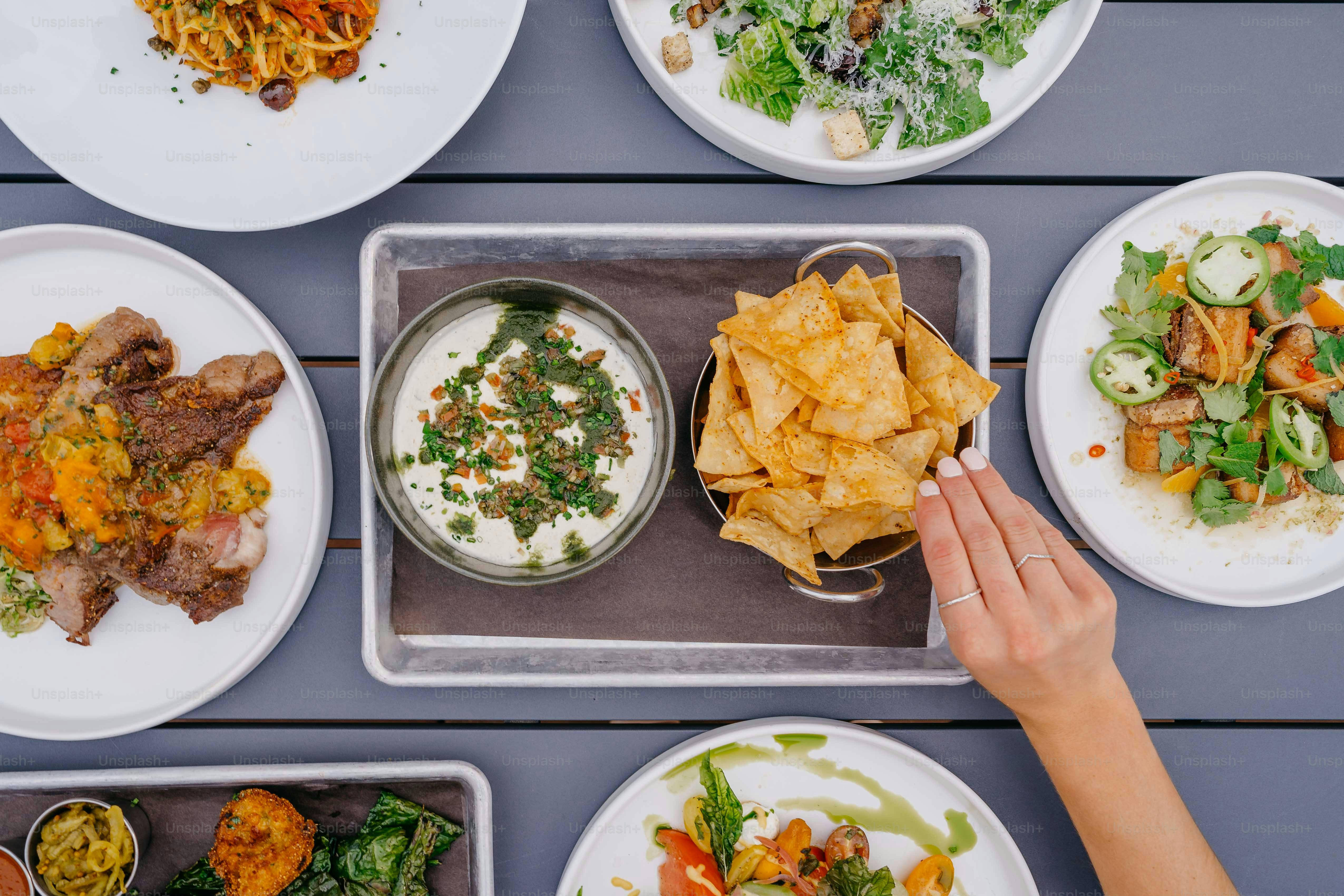 A table topped with lots of plates of food photo – Lunch Image on Unsplash