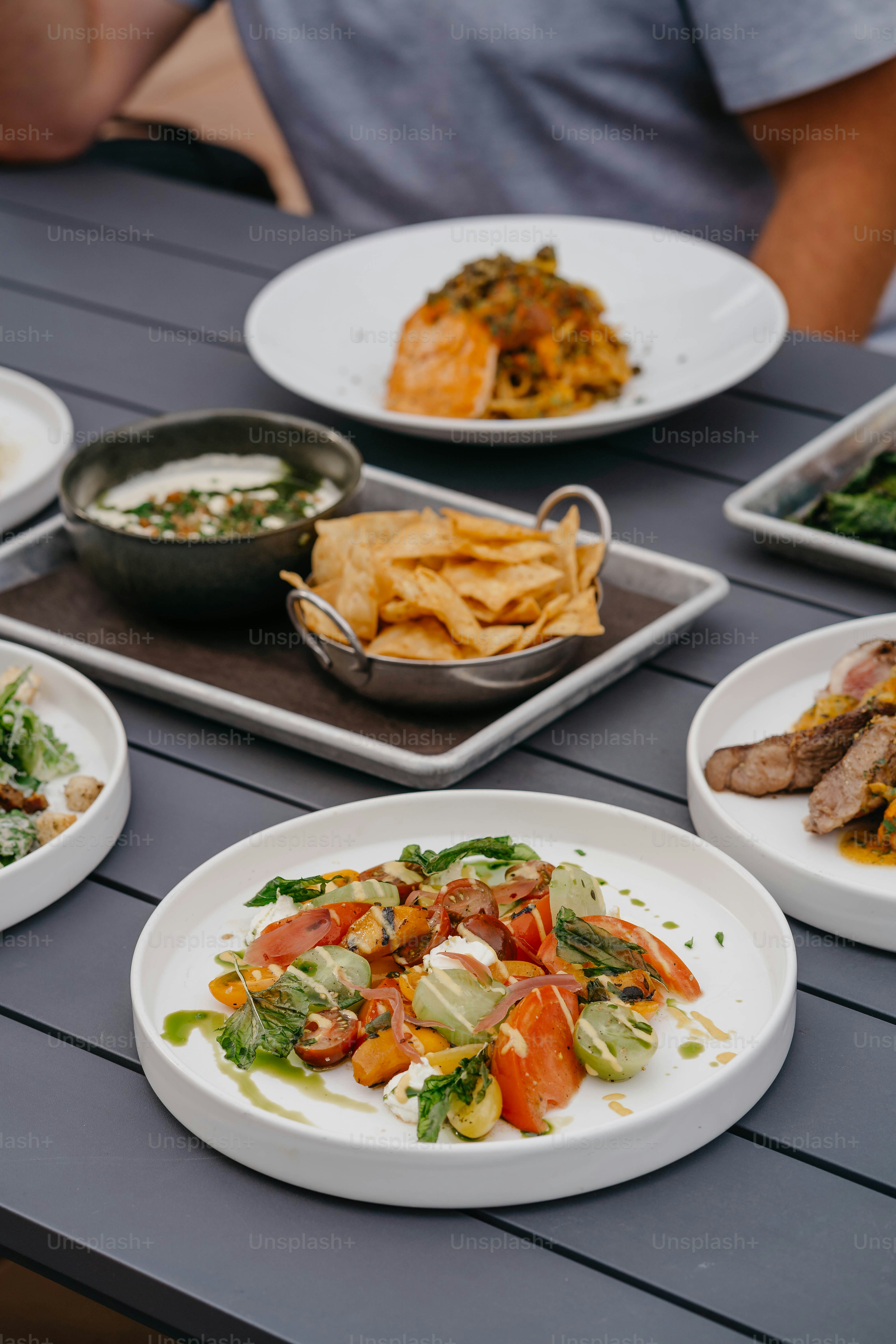 A table topped with lots of plates of food photo – Lunch Image on Unsplash