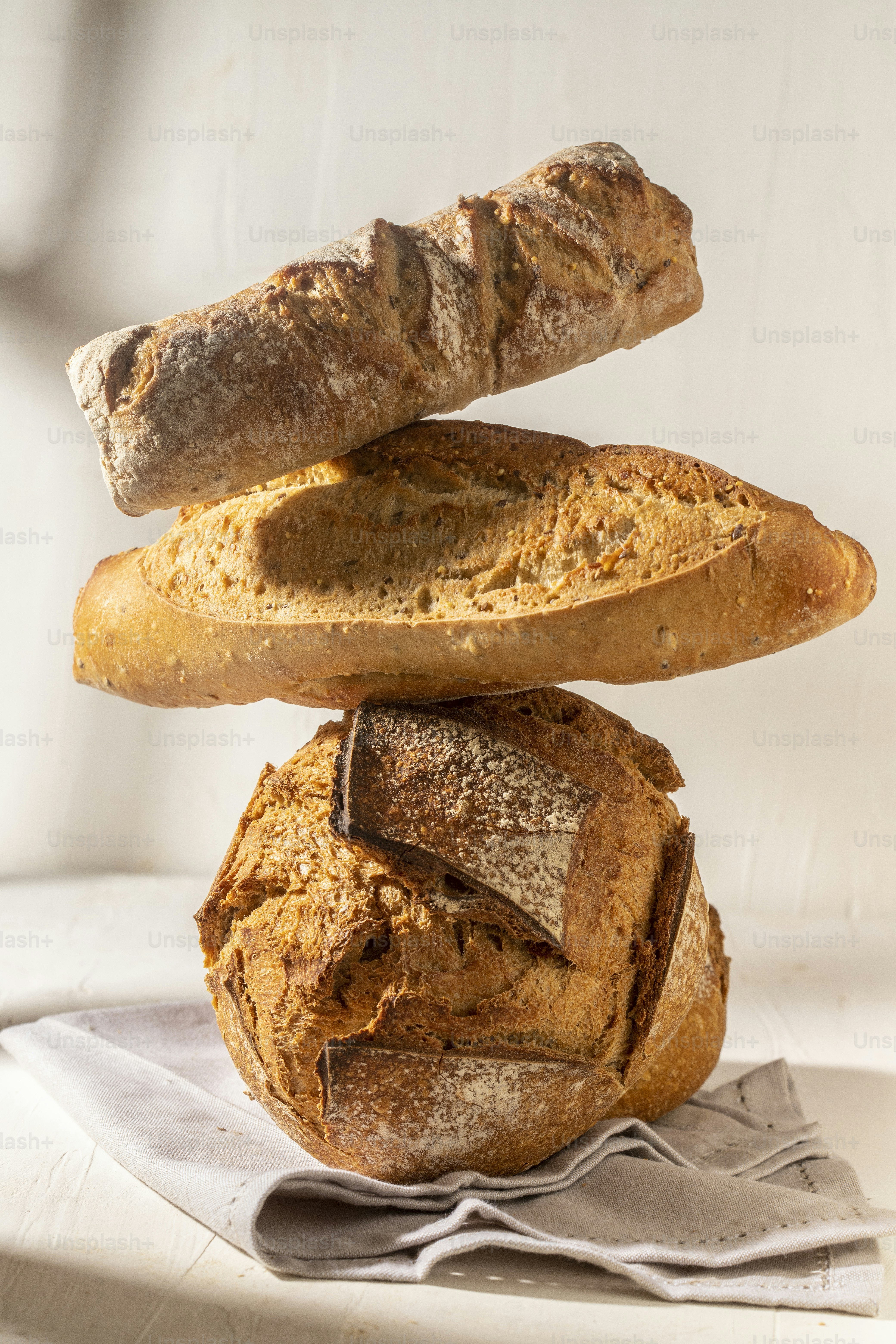 Three loaves of bread stacked on top of each other photo – Baguette ...