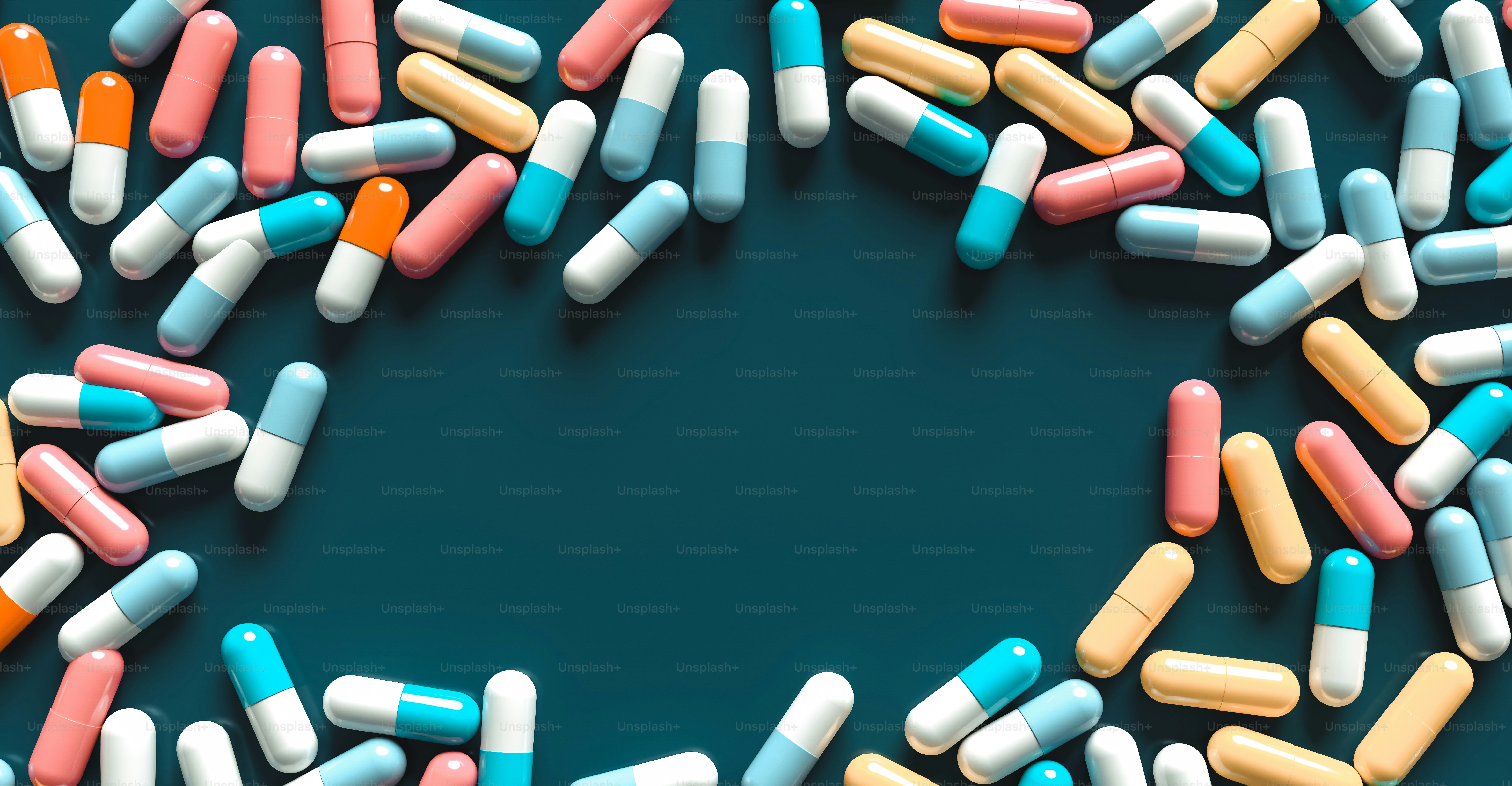 A group of pills sitting on top of a blue surface photo – Healthcare ...