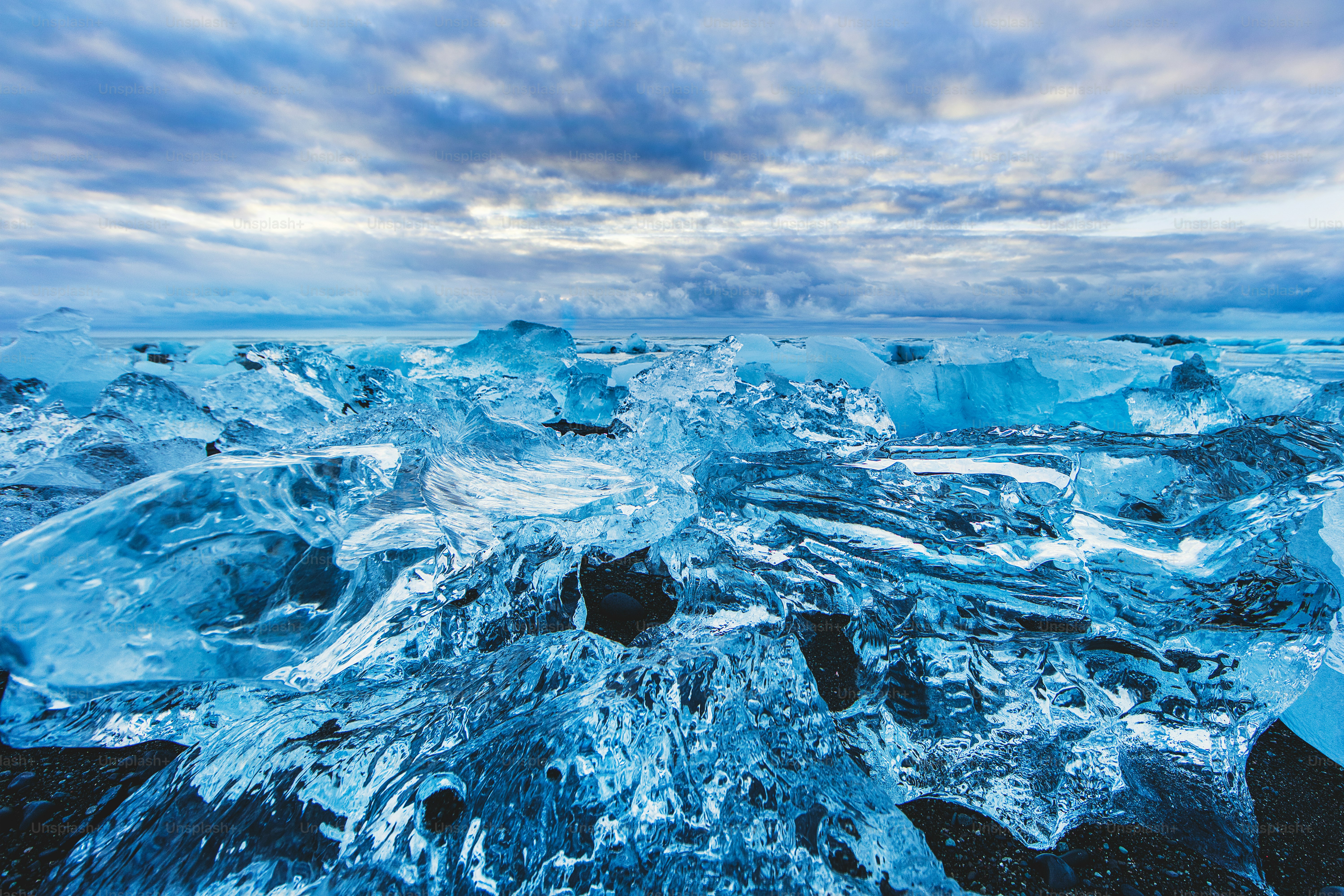 A large iceberg floating on top of a body of water photo – Icey Image ...