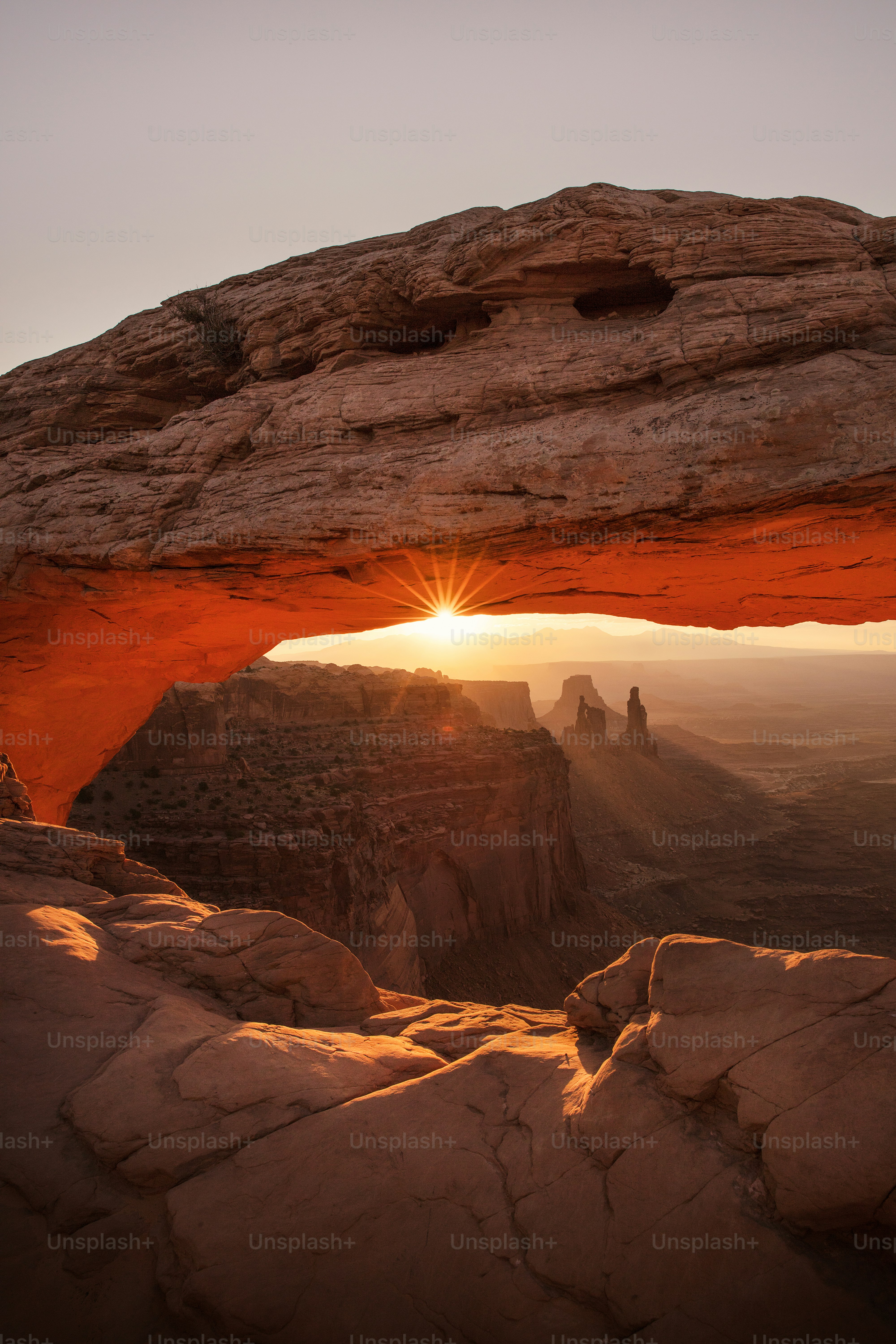 The sun is setting over a desert landscape photo – Monument valley ...