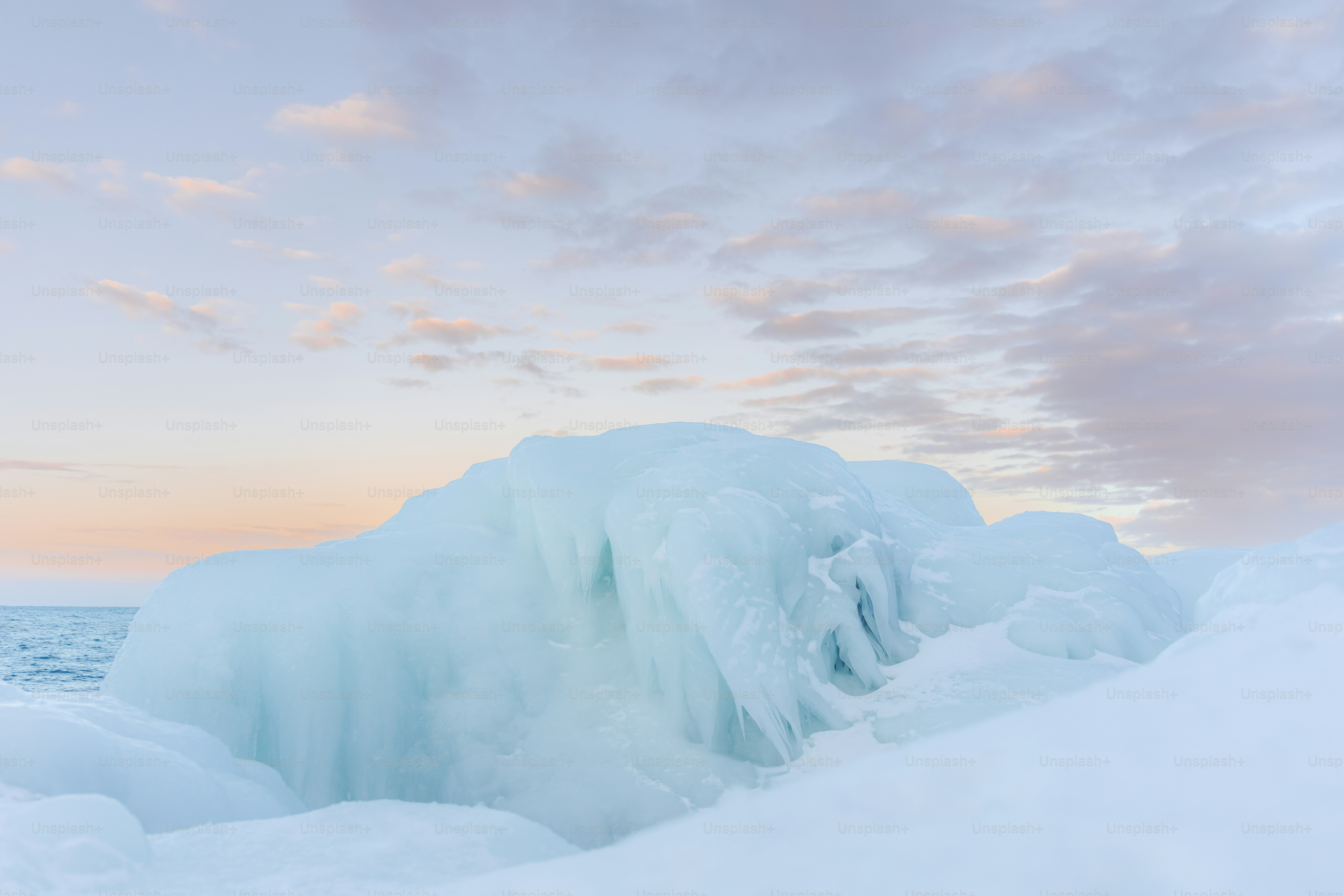 A large iceberg in the middle of a body of water photo – Iced Image on ...
