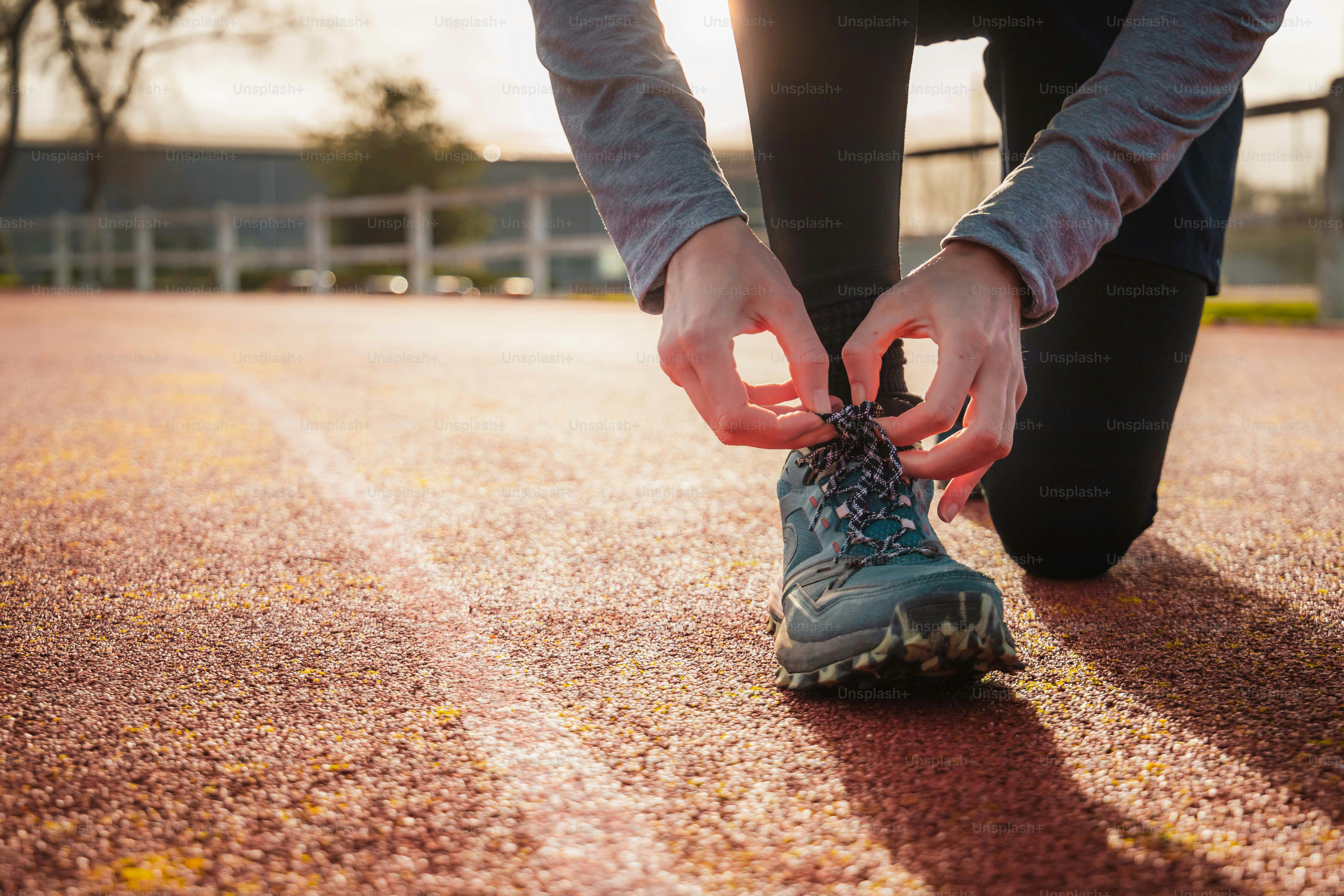Foto Una persona atando un cordón de zapatos en una cancha de tenis ...