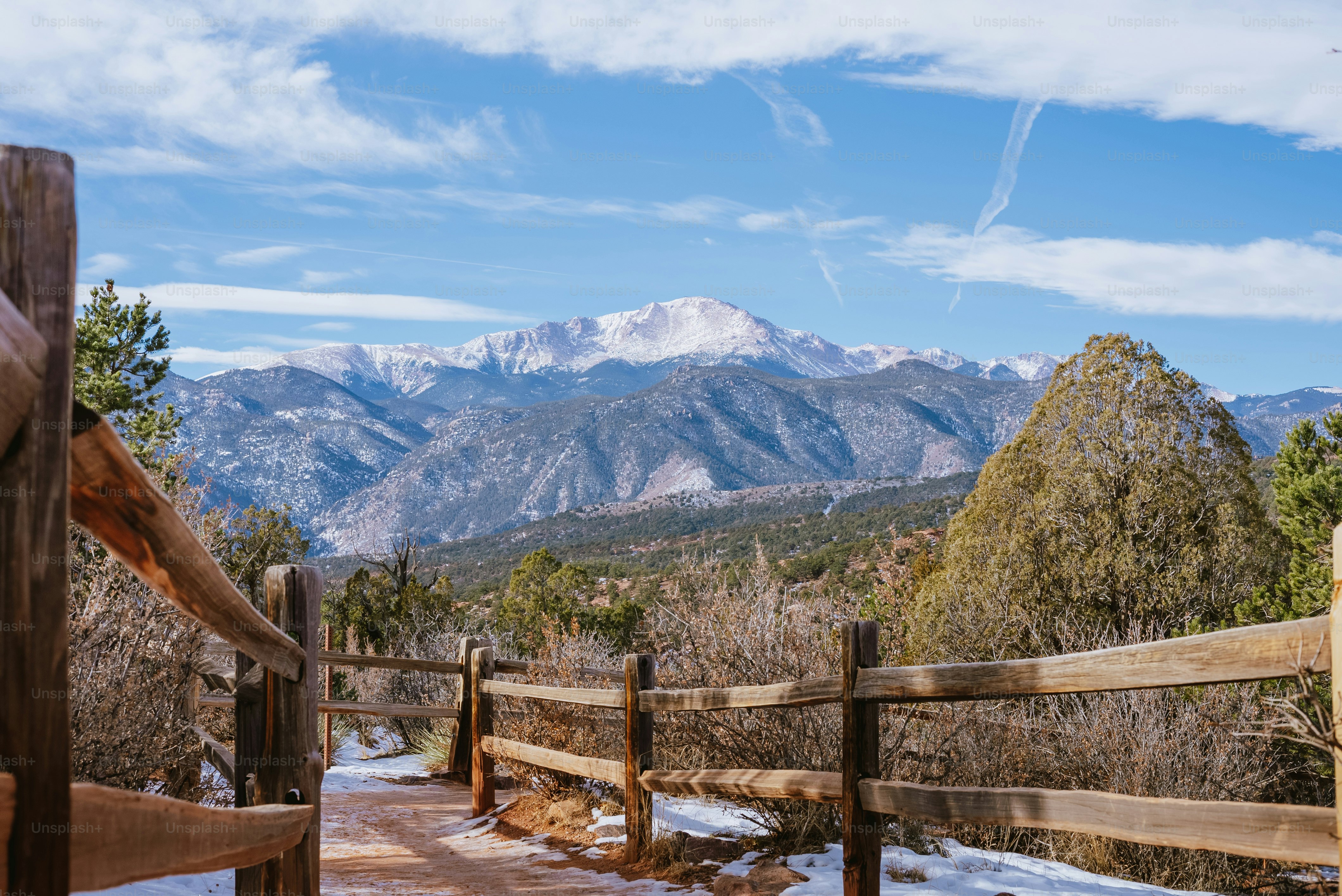 A wooden fence with a mountain view in the background photo – Garden of ...