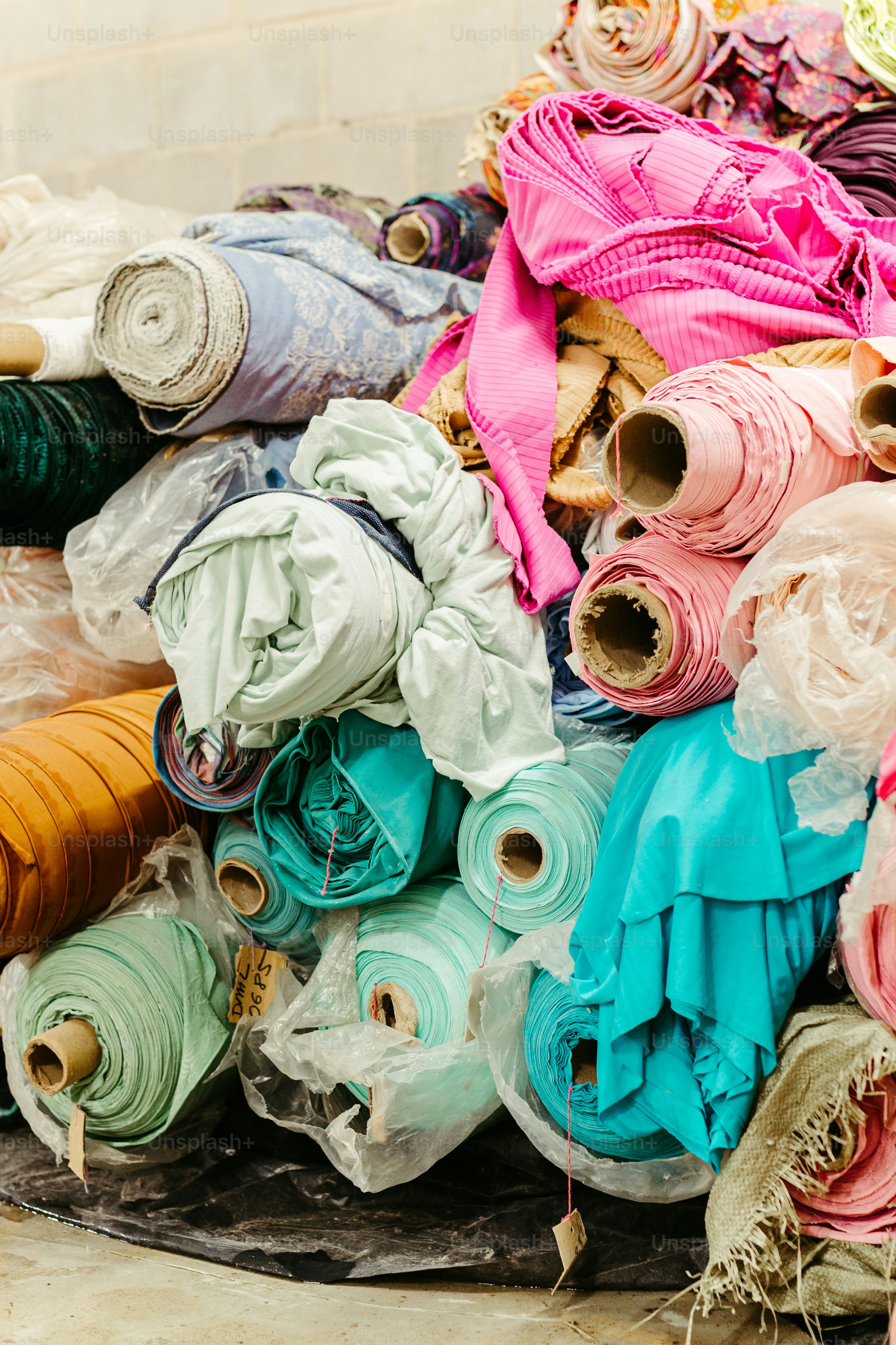 A pile of different colored yarns on the ground photo – Fashion Image ...