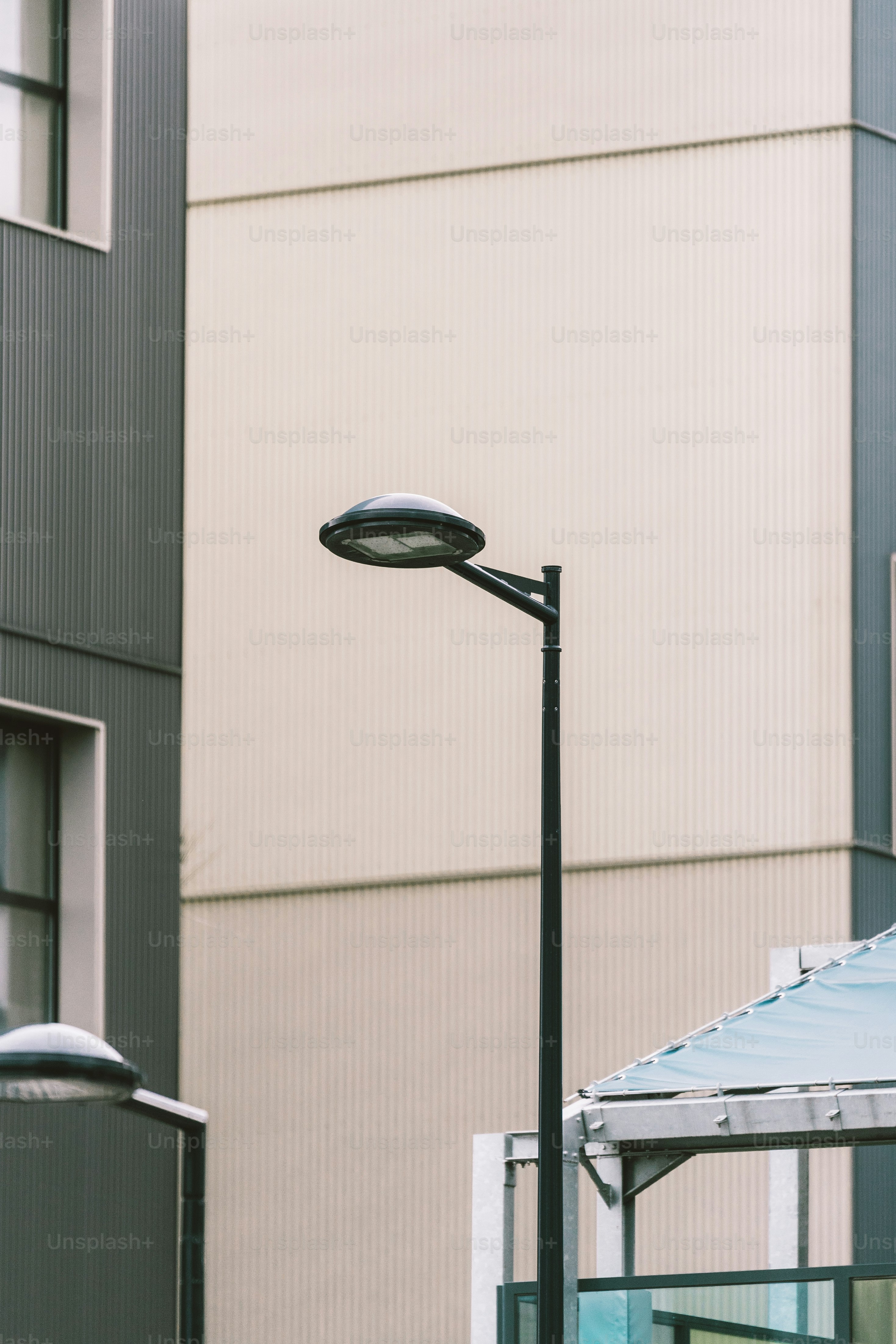 A street light in front of a building photo – Street lamp Image on Unsplash