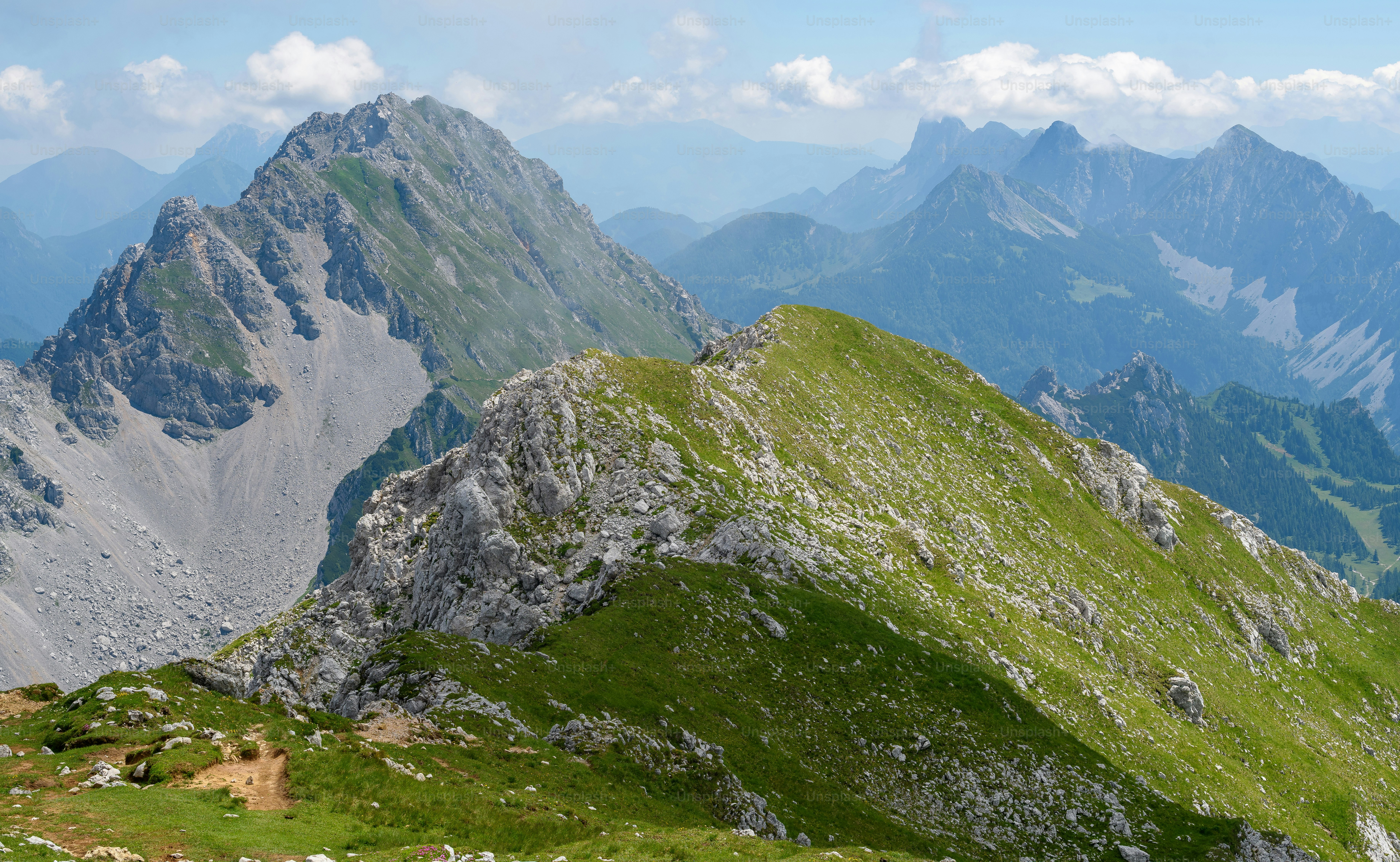 A view of the mountains from the top of a mountain photo – Natural ...