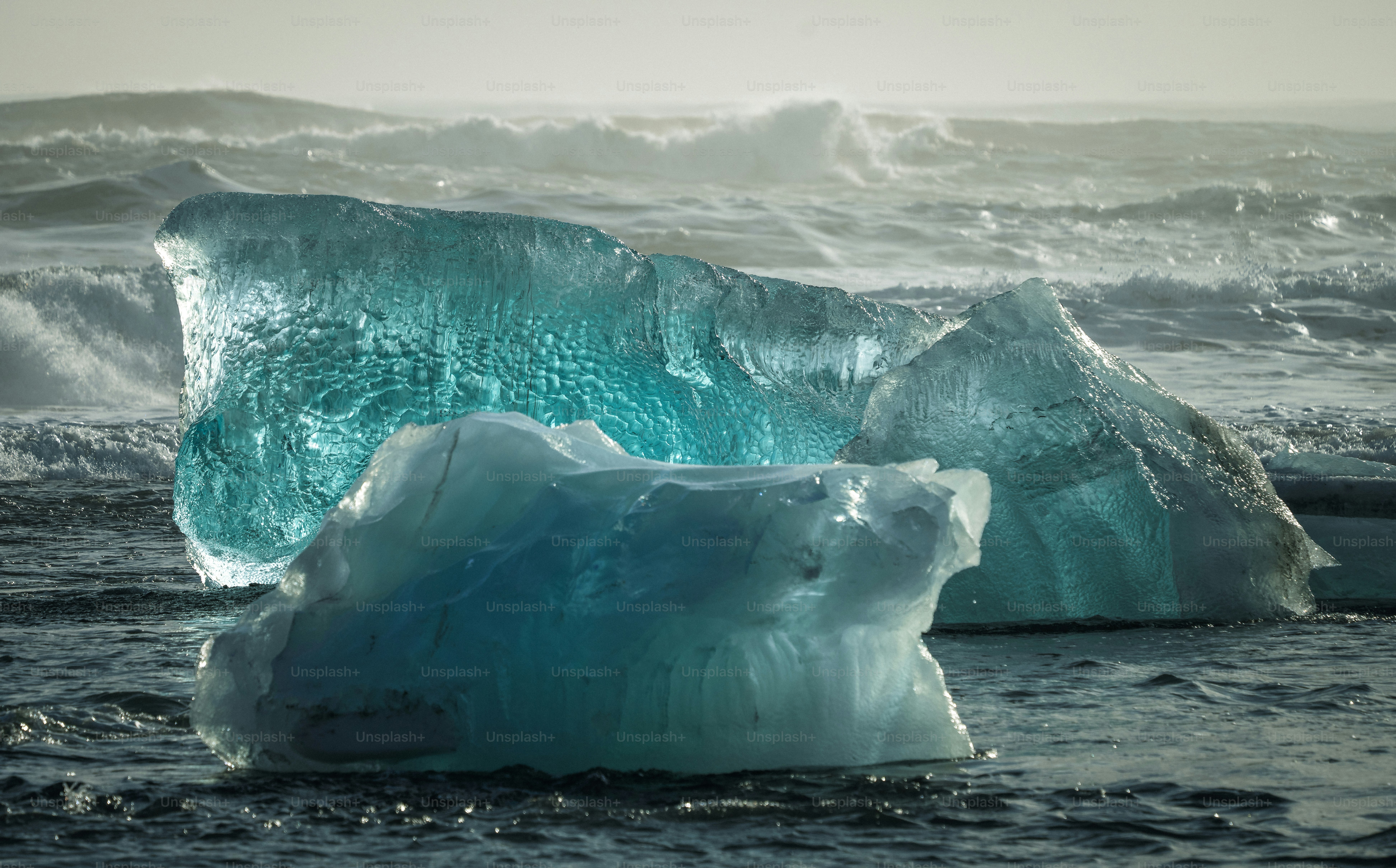 A large iceberg floating on top of a body of water photo – Iceland ...