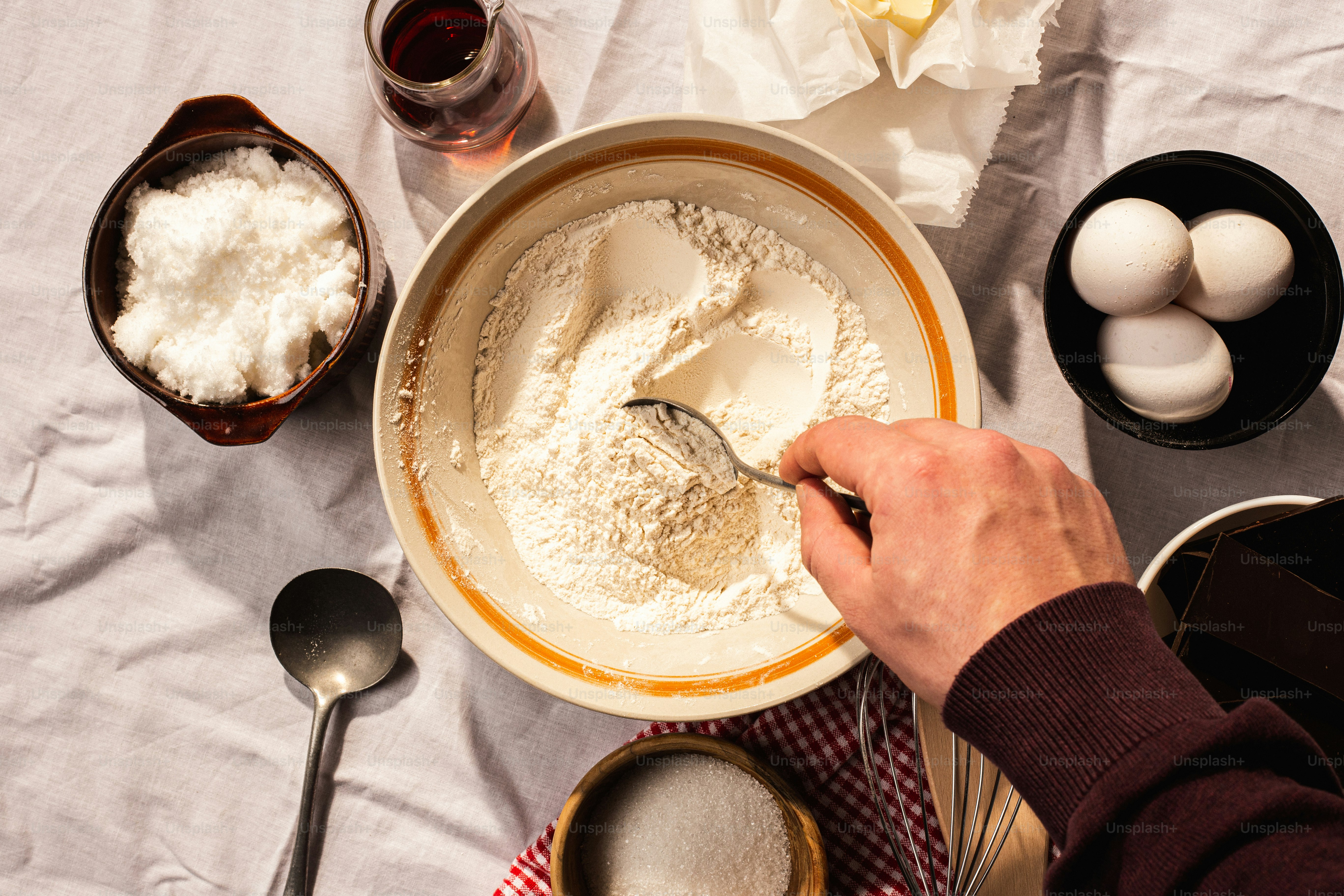 A person mixing ingredients in a bowl on a table photo – Chocolate chip ...