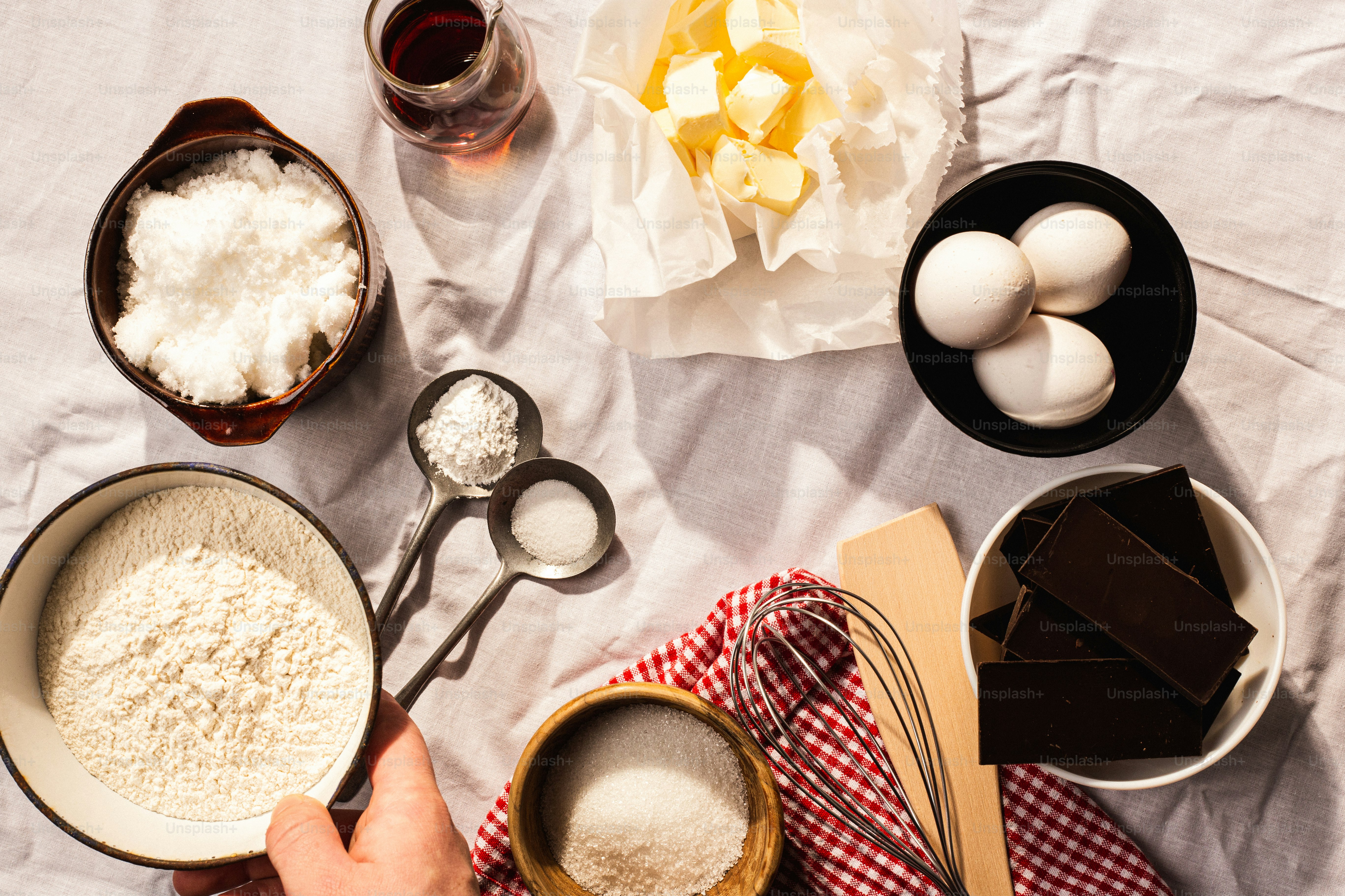 A table topped with bowls of food and utensils photo – Dark chocolate ...