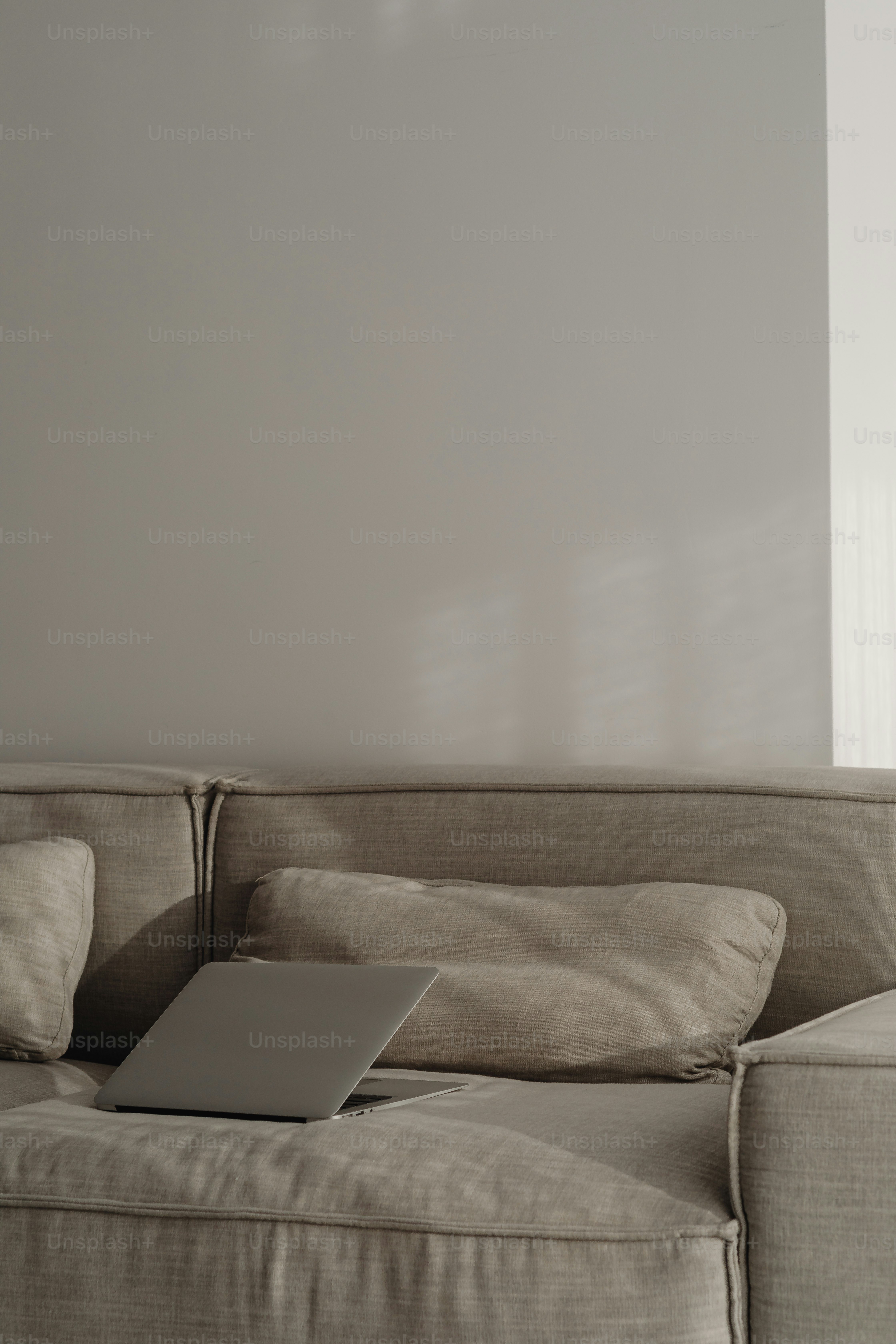 A laptop computer sitting on top of an ottoman photo – Computer Image ...