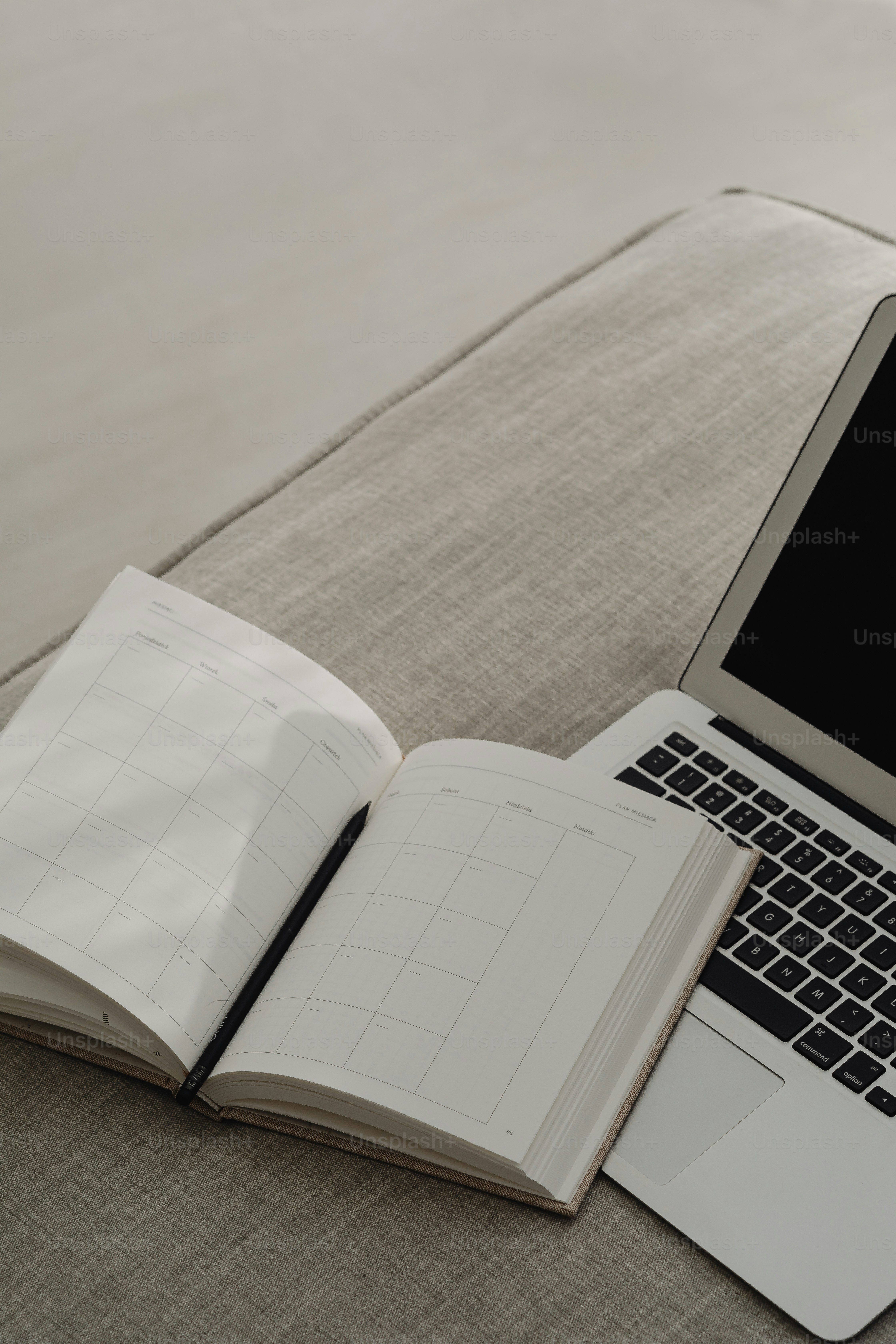 A laptop computer sitting on top of a couch photo – Minimalistic Image ...