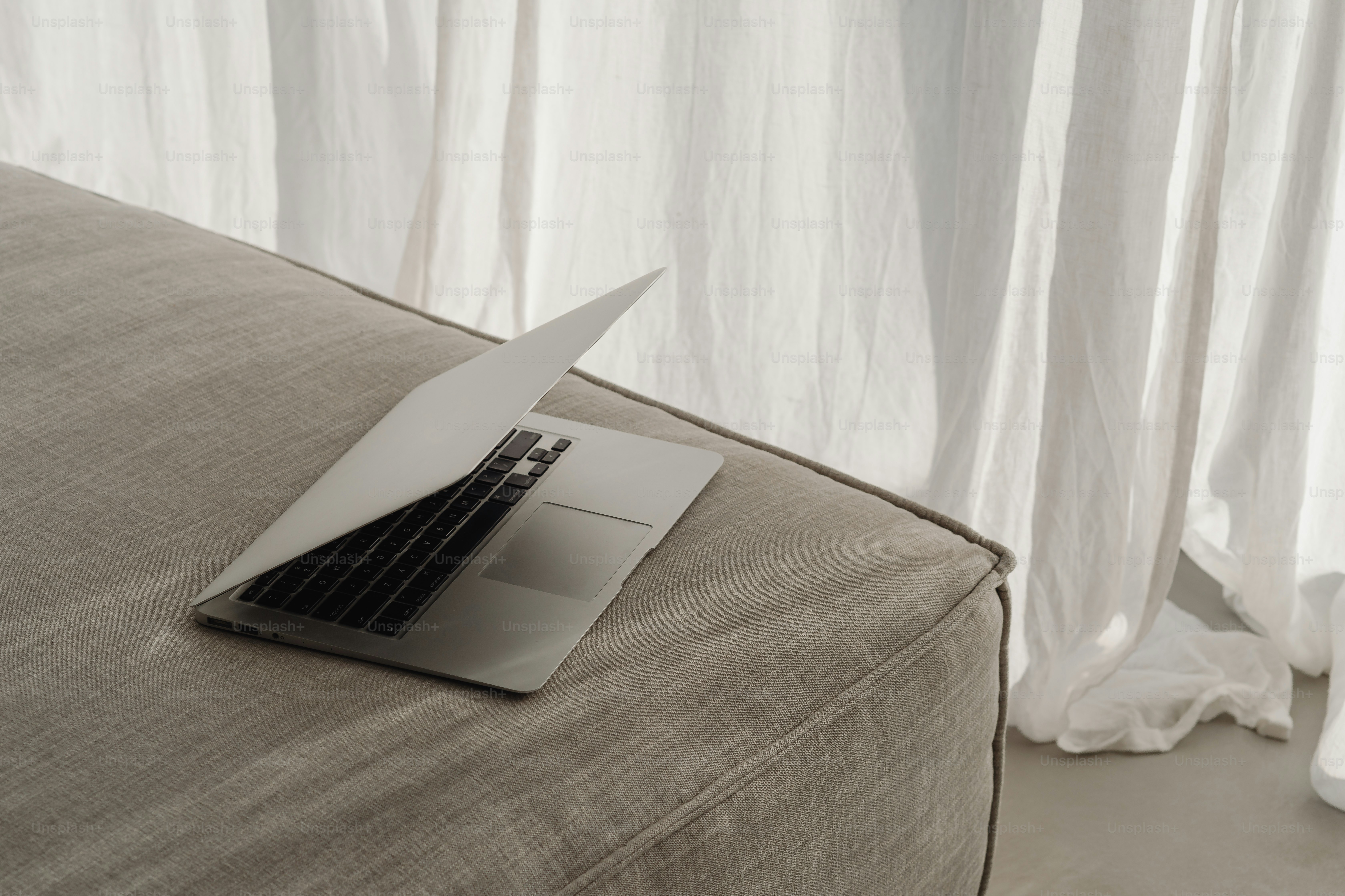 A laptop computer sitting on top of a couch photo – Couch Image on Unsplash