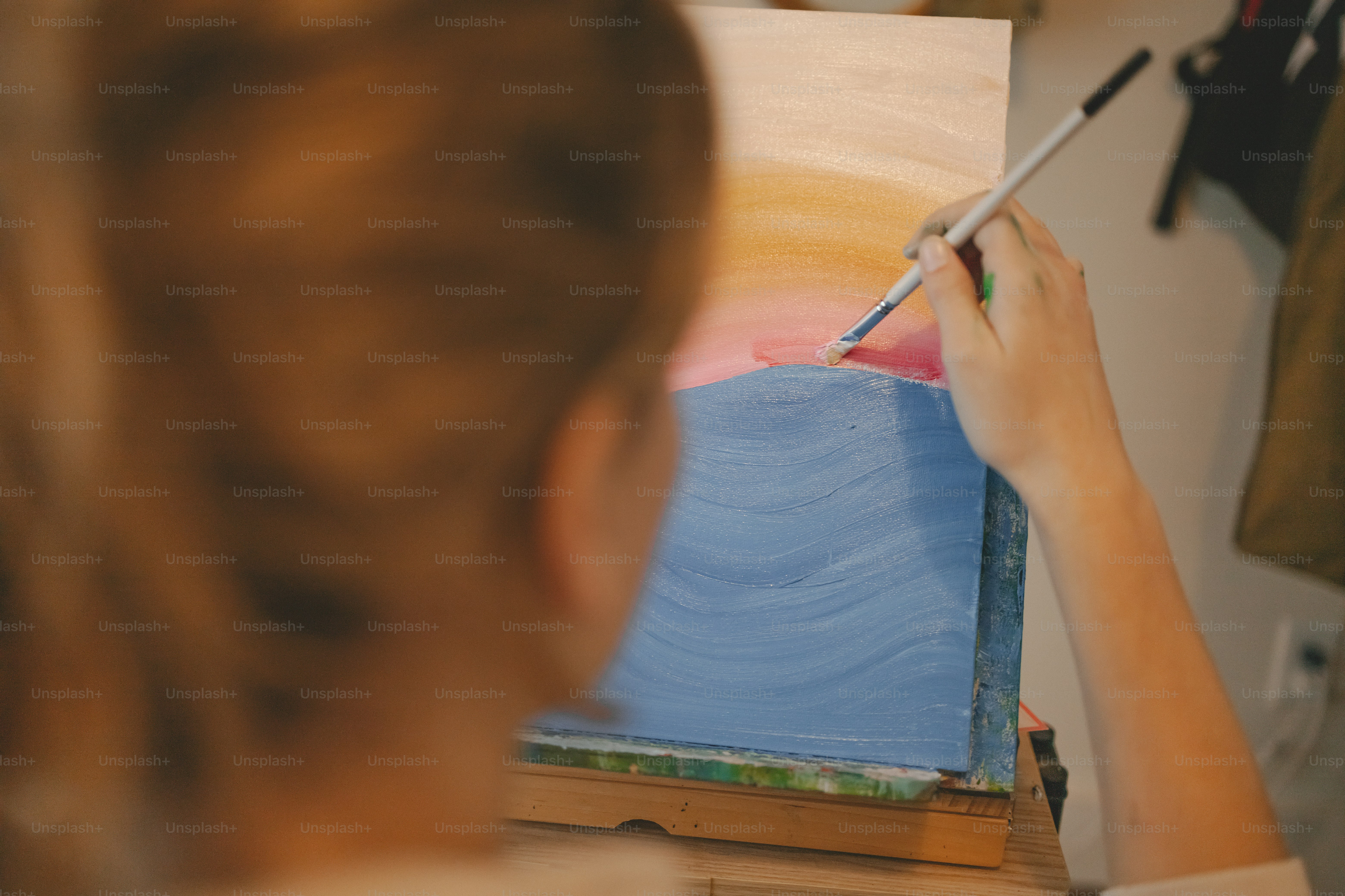 A woman is painting a picture on a canvas photo – Art supplies Image on ...