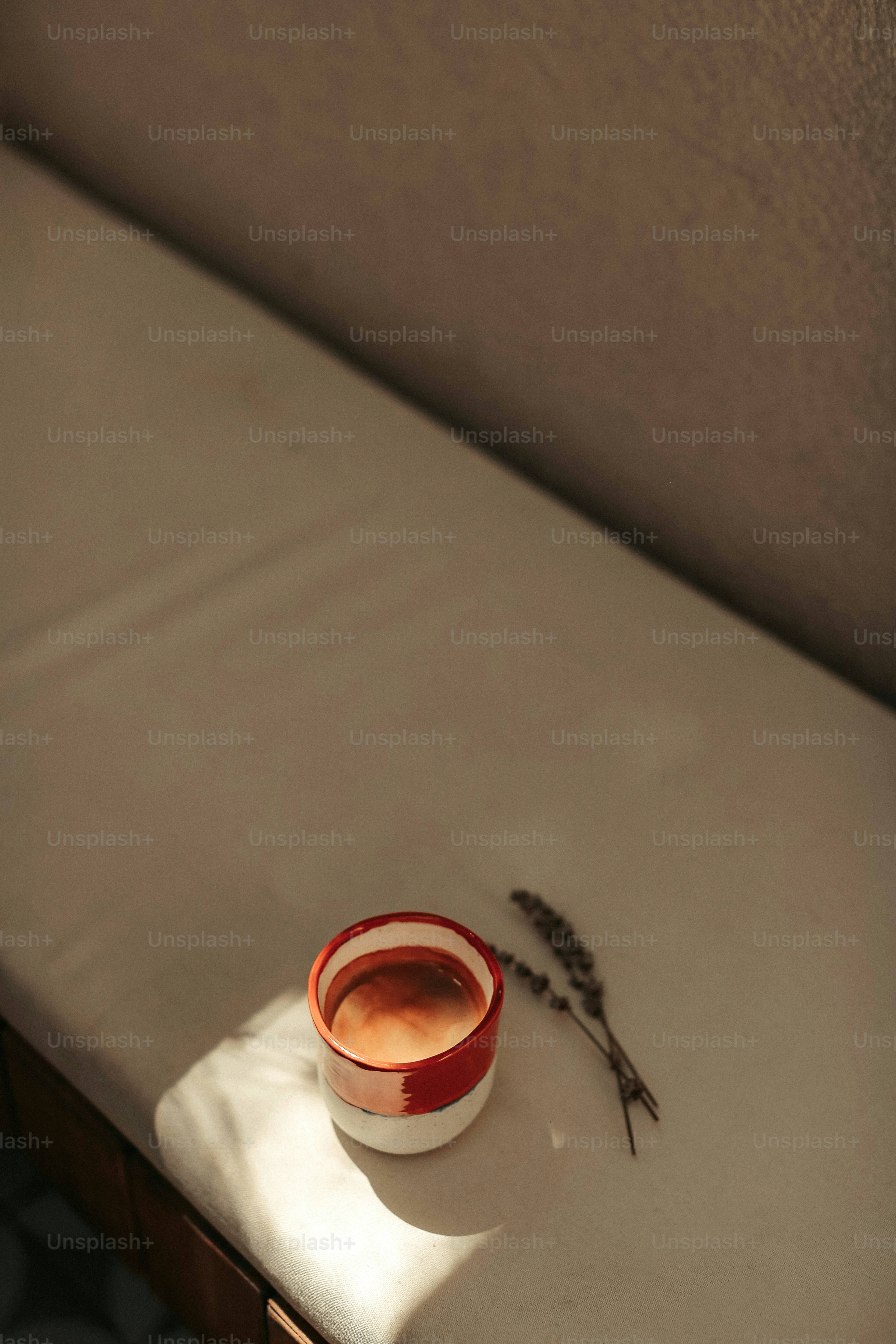 A small cup of tea sits on a bed photo – Espresso coffee Image on Unsplash