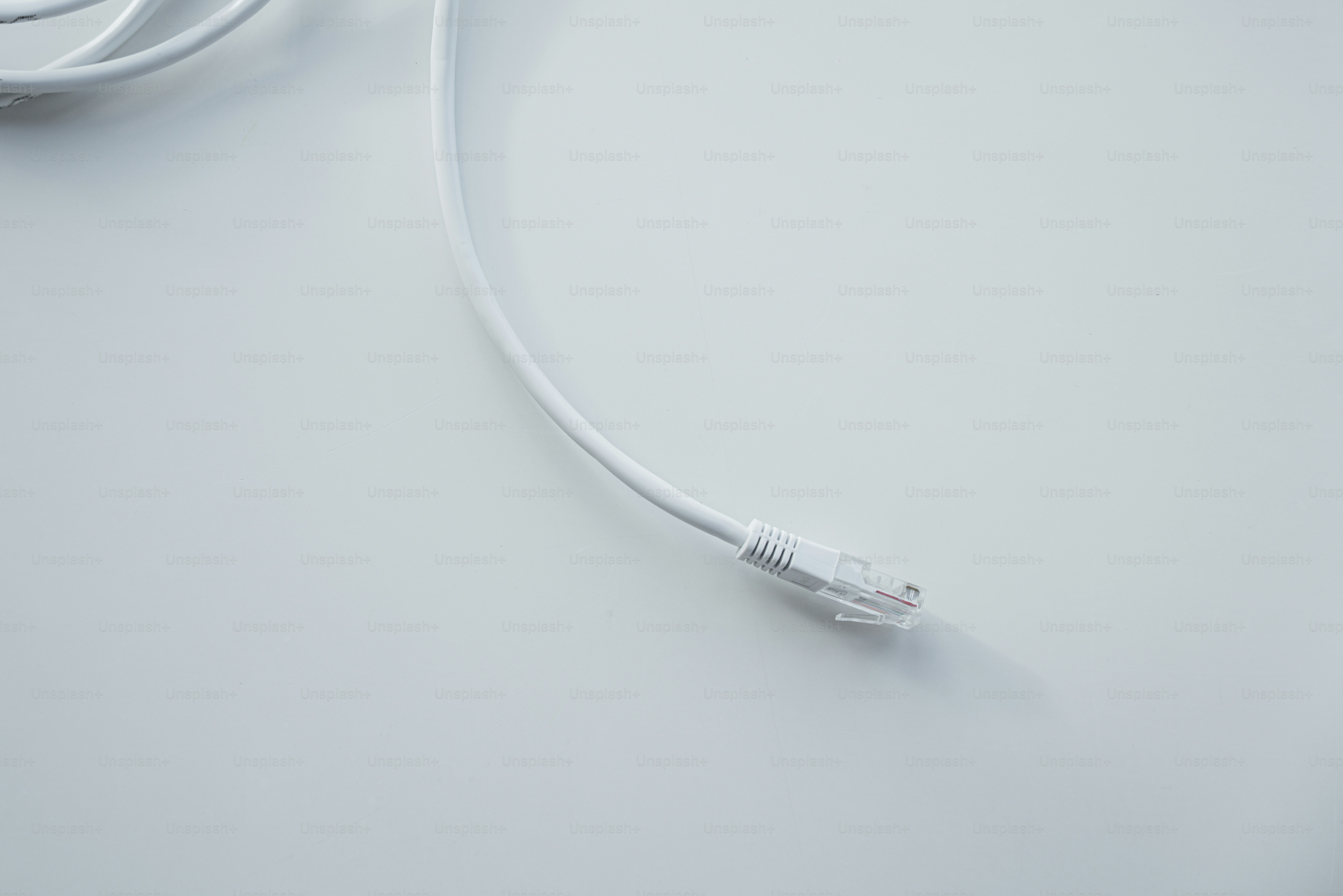 A close up of a white cord on a white surface photo – Internet Image on ...
