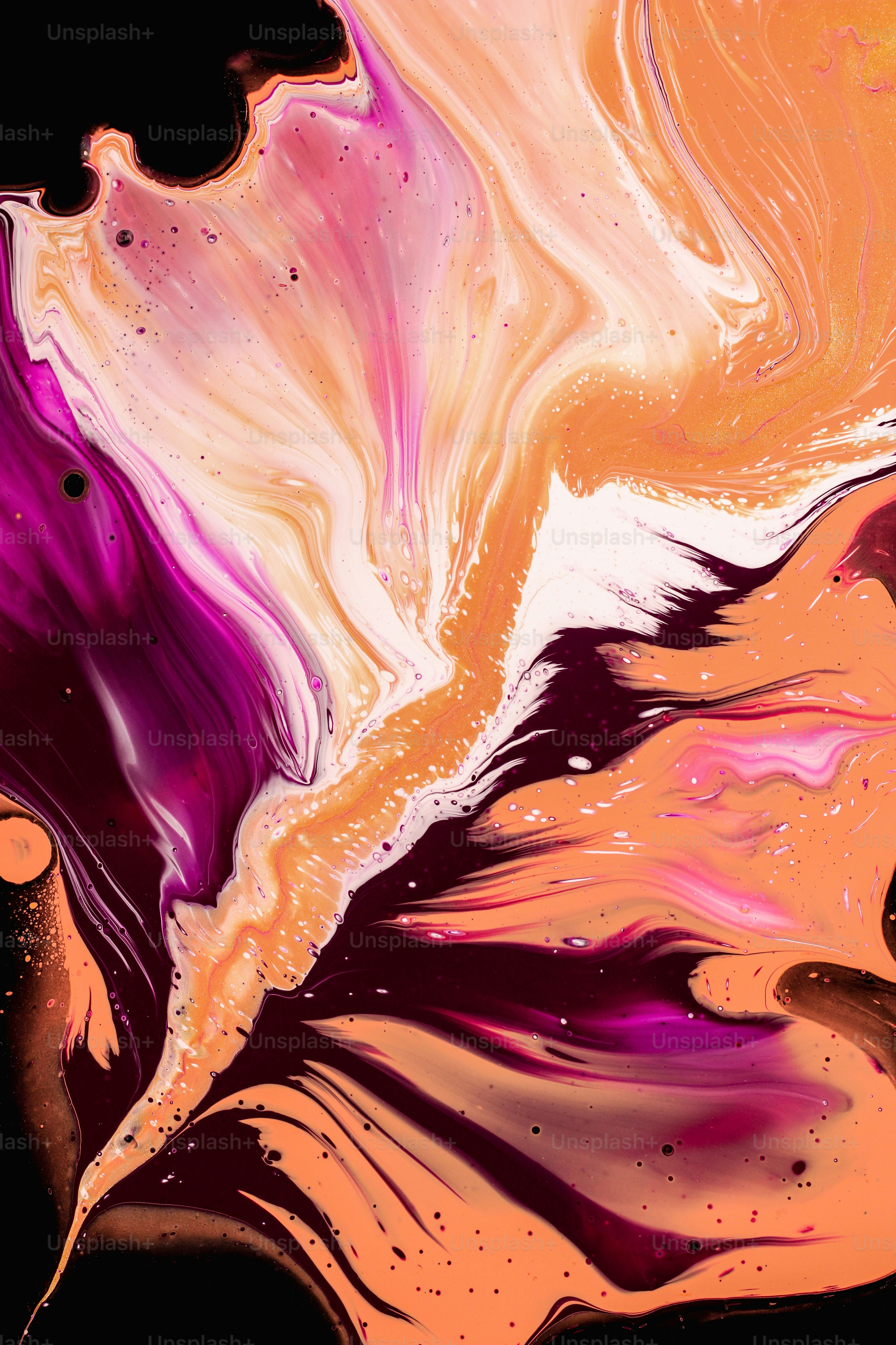 A close up of a cell phone with an orange and purple design photo ...