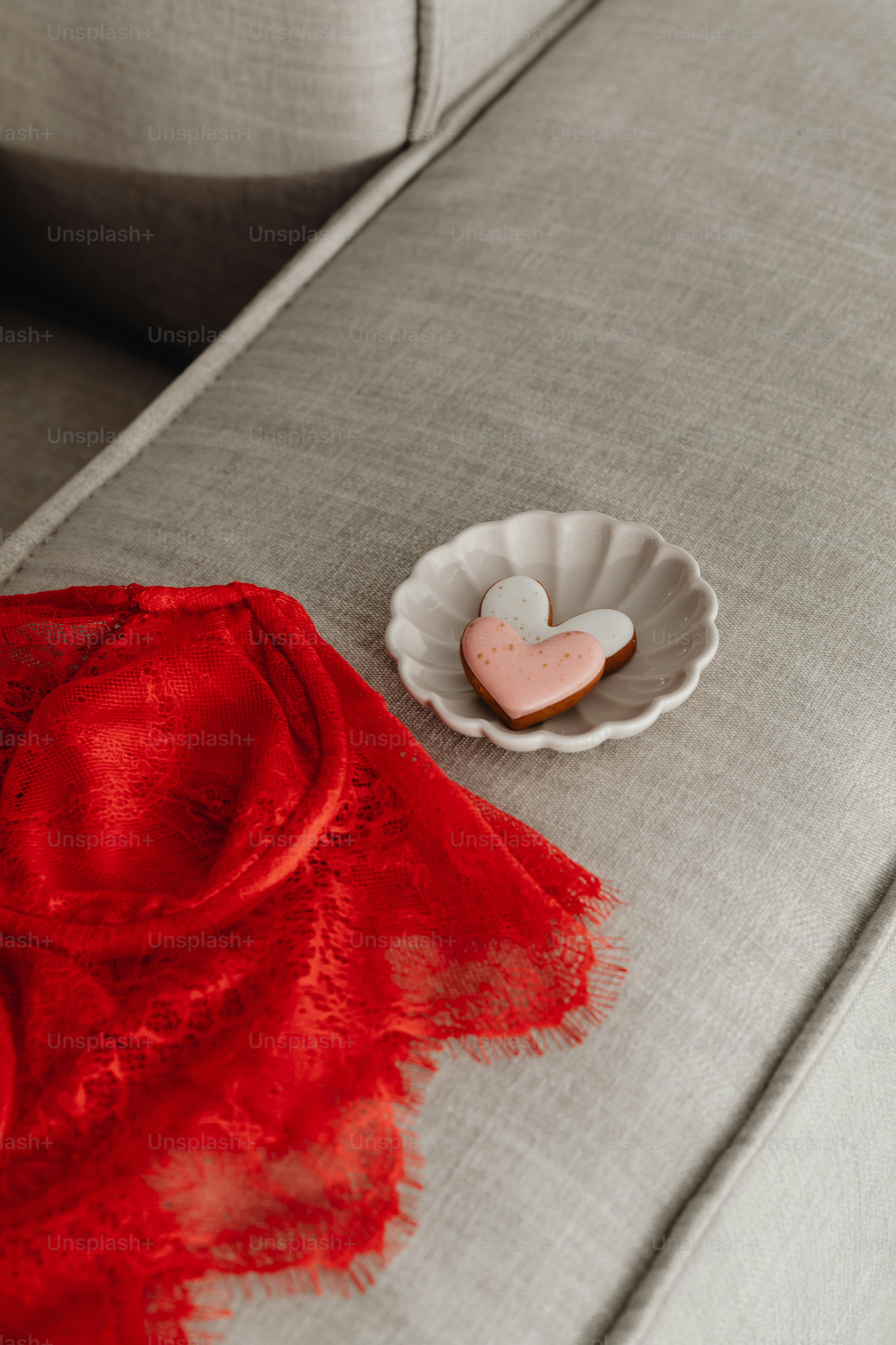 A table topped with plates of heart shaped cookies photo – Background ...